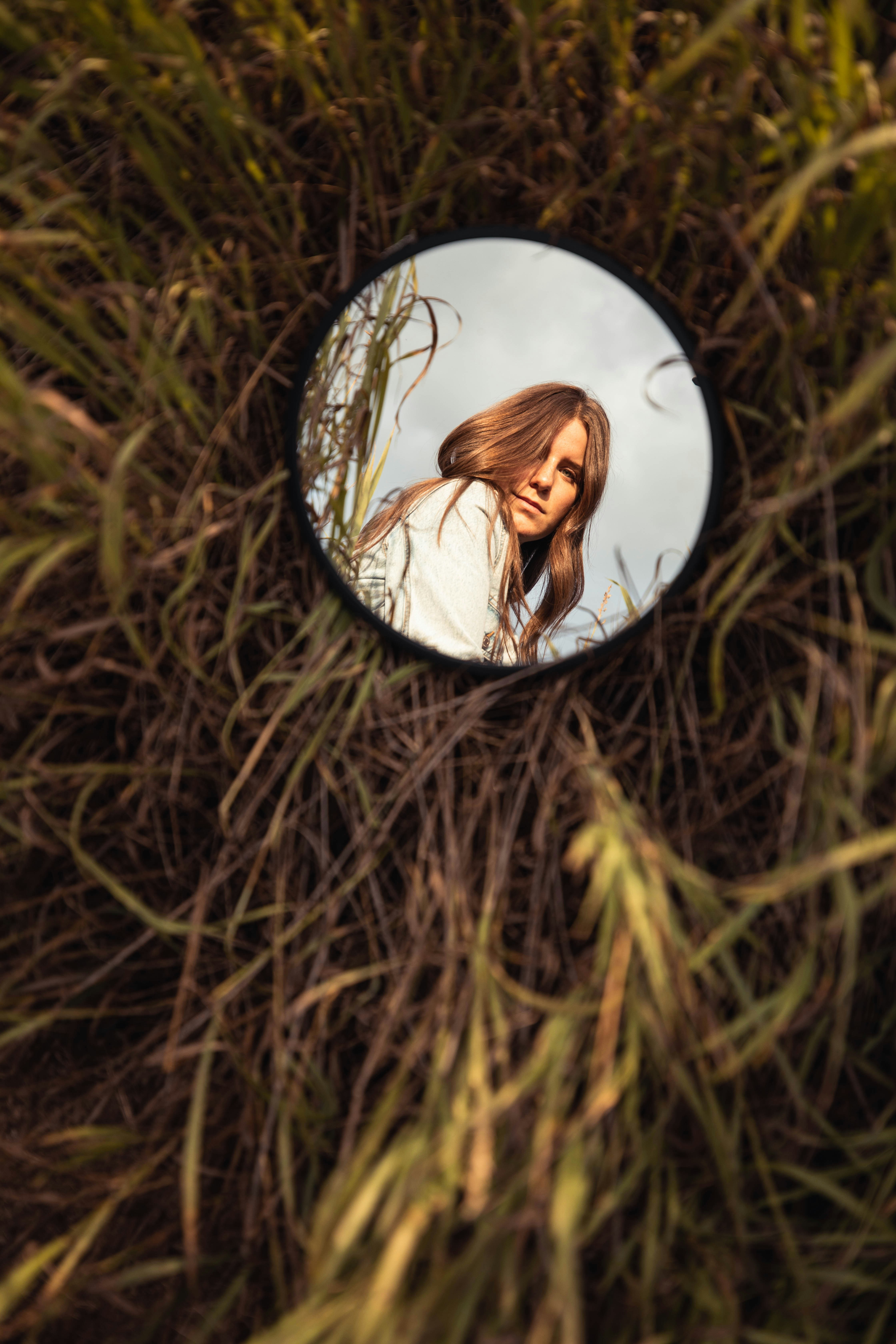 Gaze Through a Grass Ring: Portrait Reflected in a Circular Mirror
