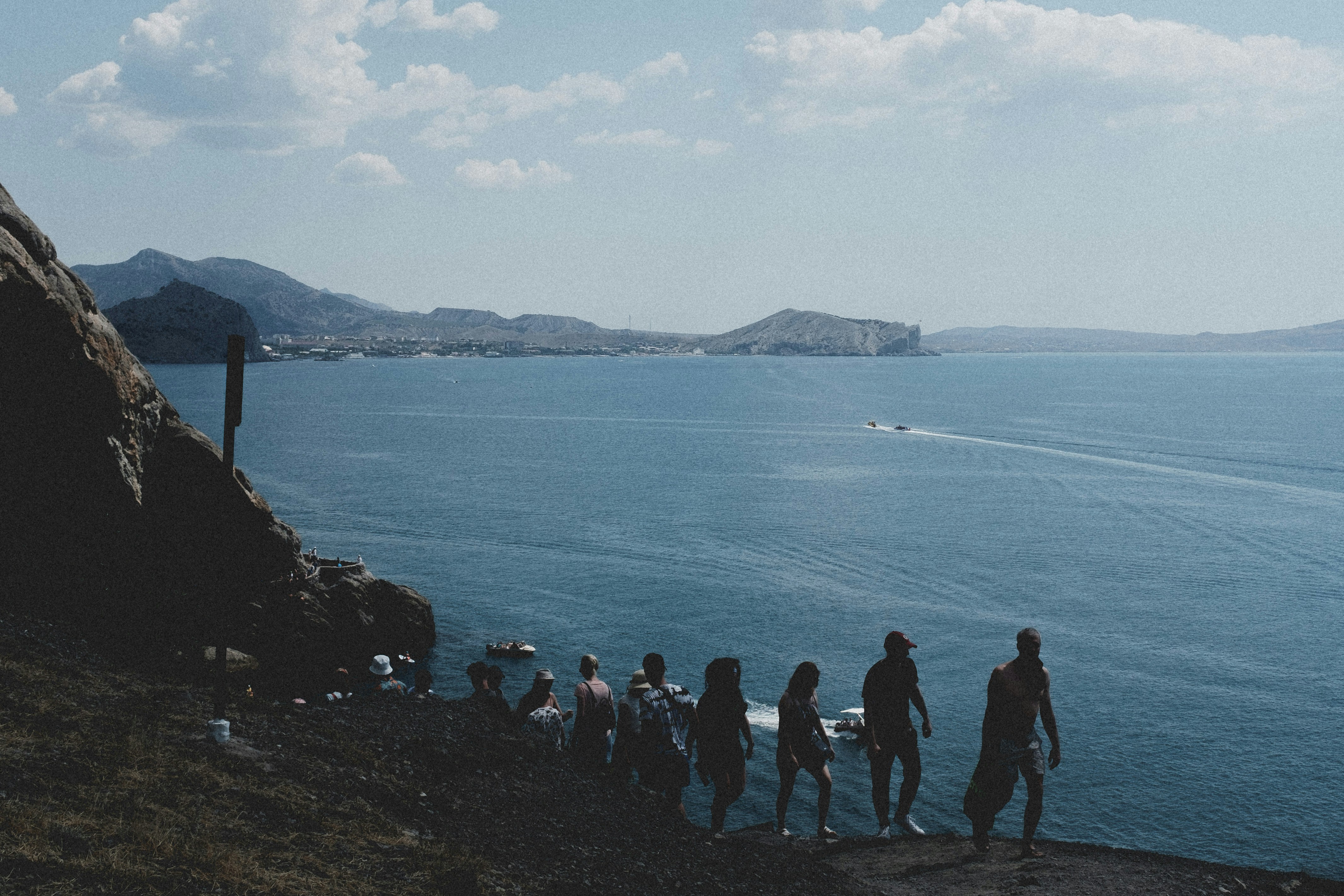 People standing on rock formation near sea during daytime photo – Free ...