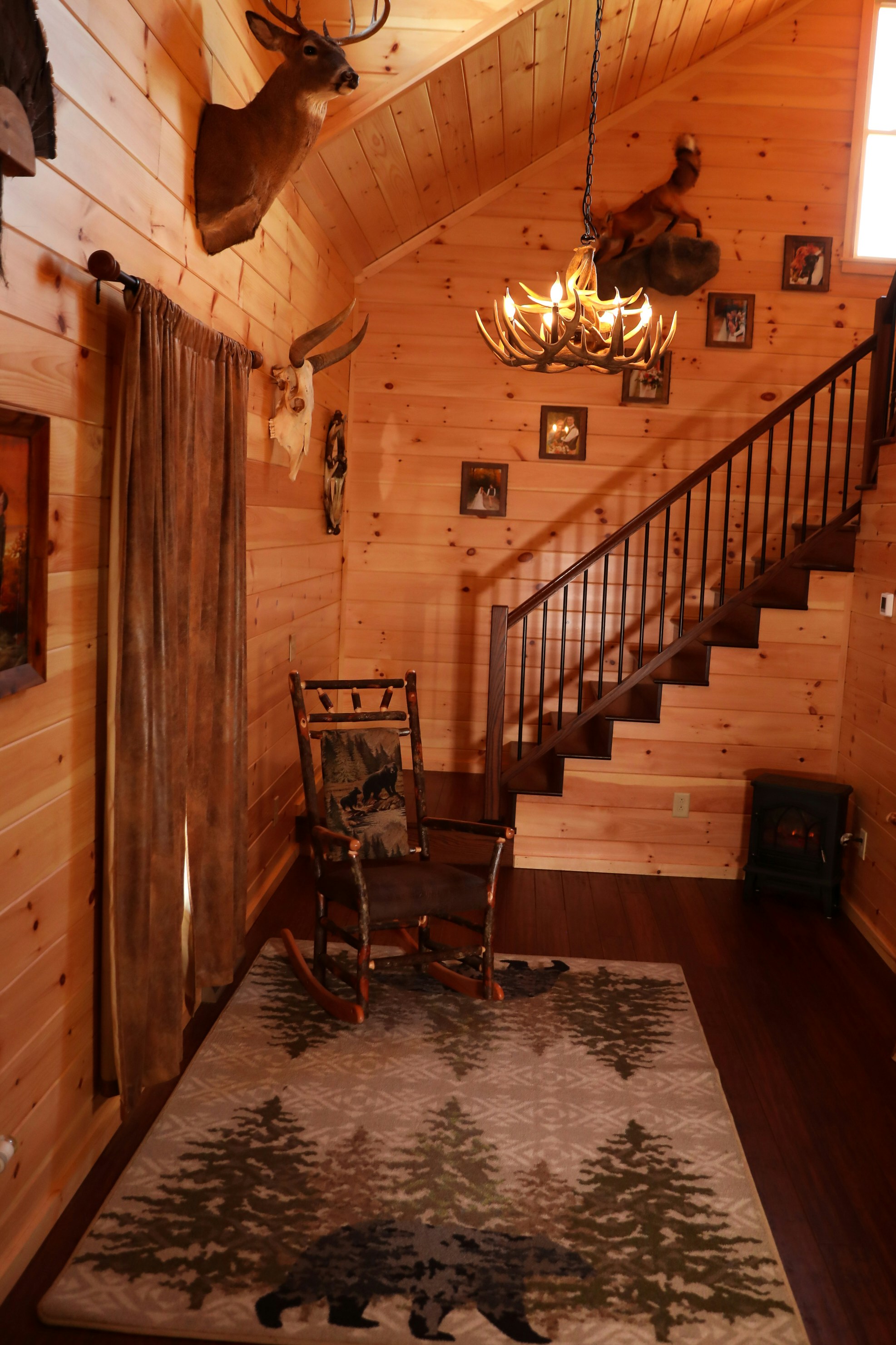 Cozy Cabinscape: Deer Trophies, Staircase, and Antlered Ambience