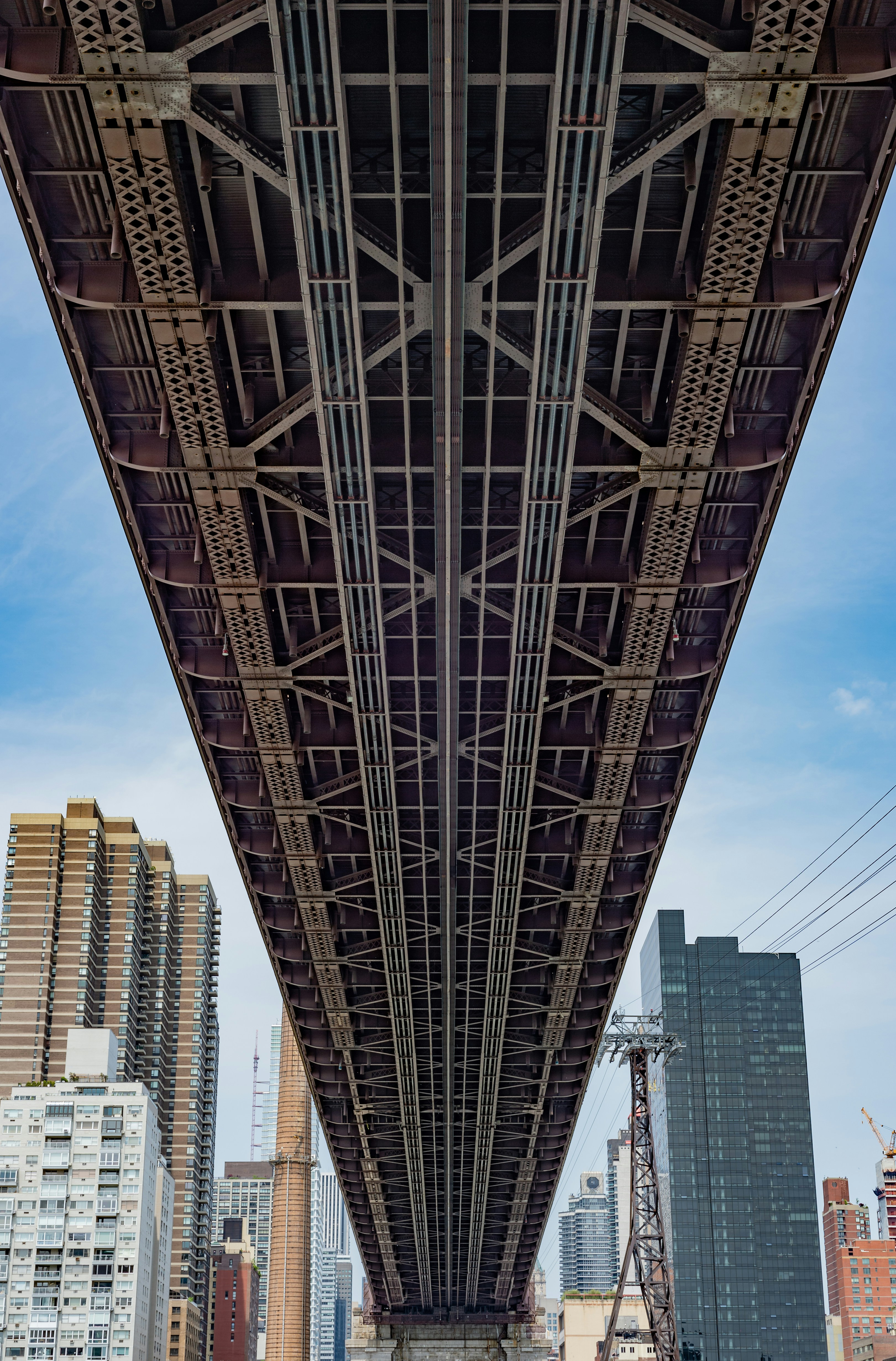 The City's Spine: Vanishing Point Under a Steel Bridge