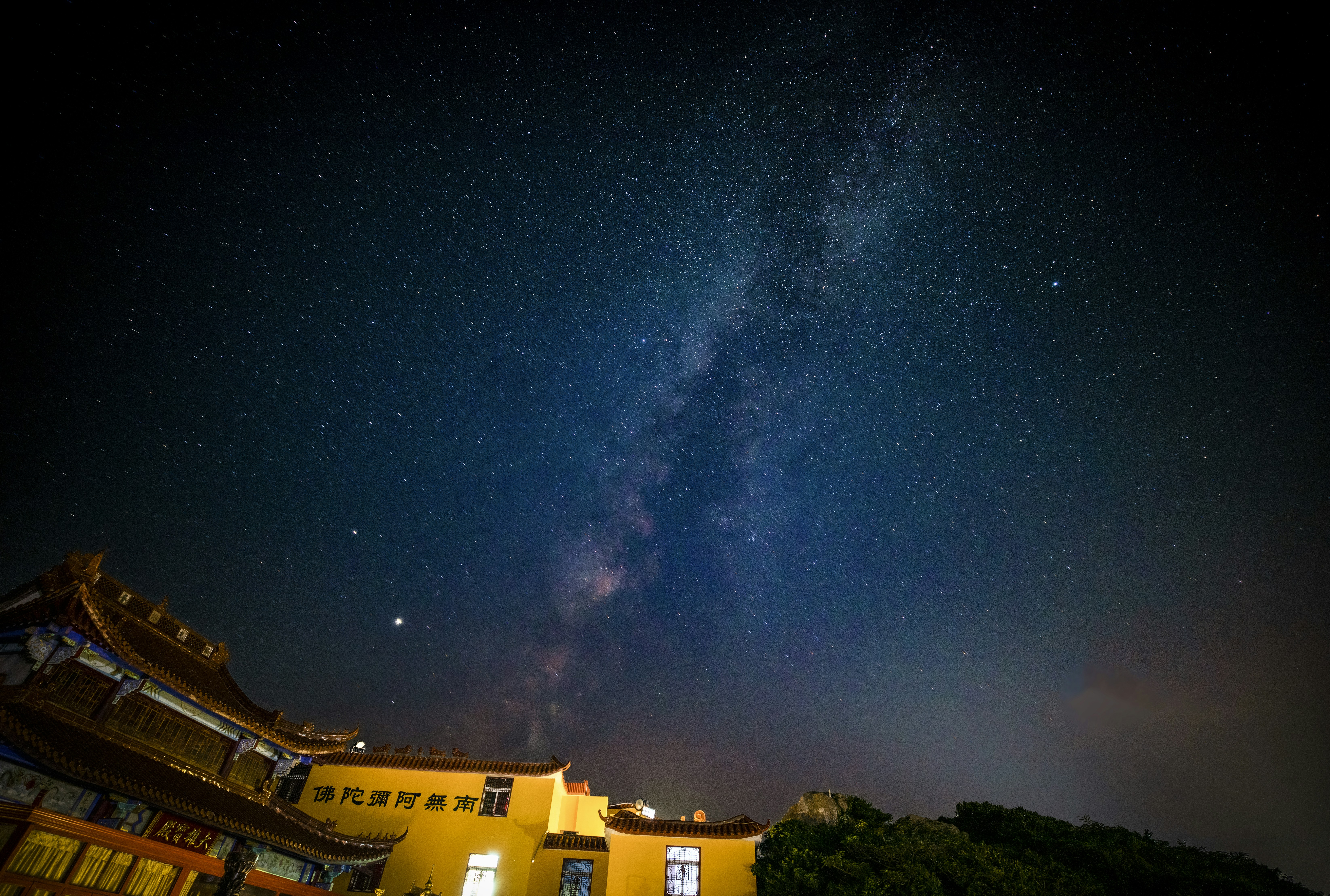 Milky Way Over Lantern-Lit Temple Row at Night