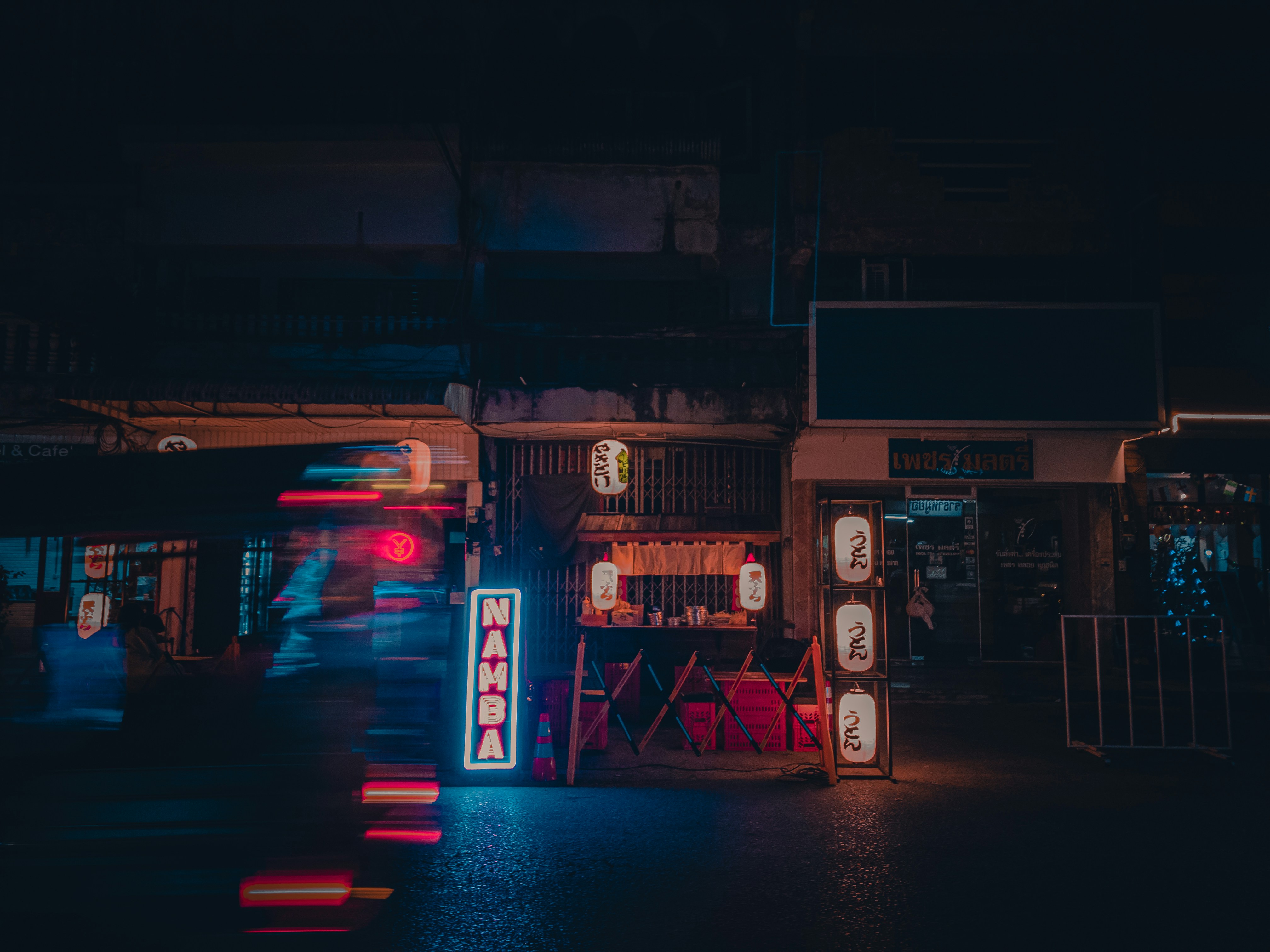 Walking alone at night time and take a shot at street food in Chiang rai , Thailand. | red and black led signage