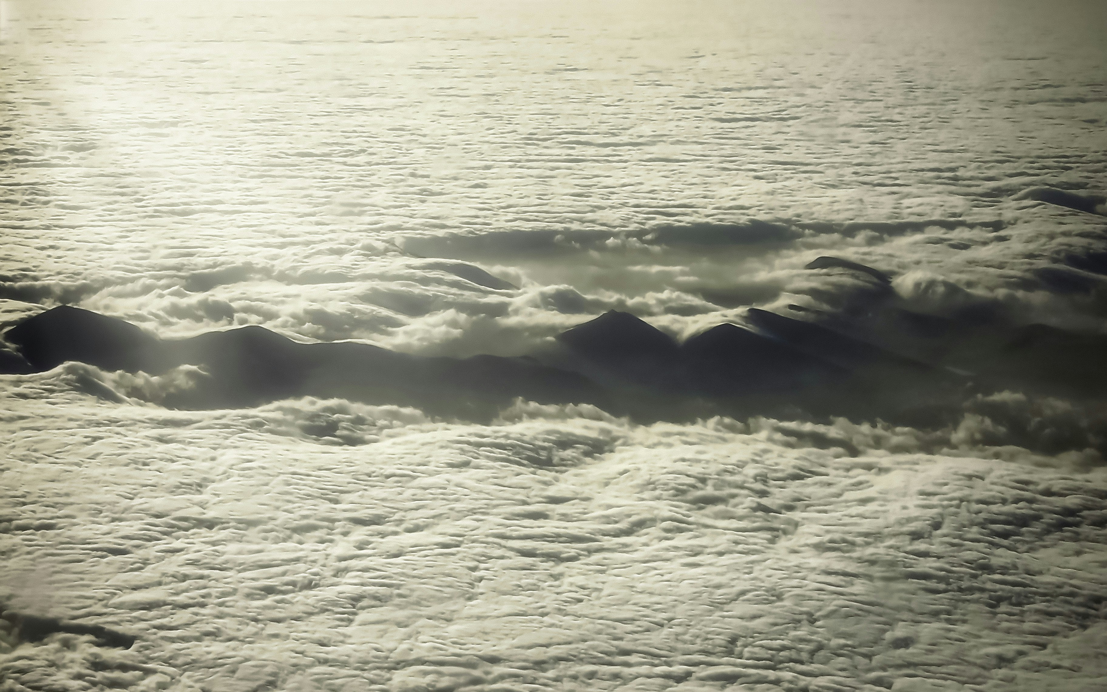 Dawn Crest: Mountain Ridges Rising Through a Sea of Clouds