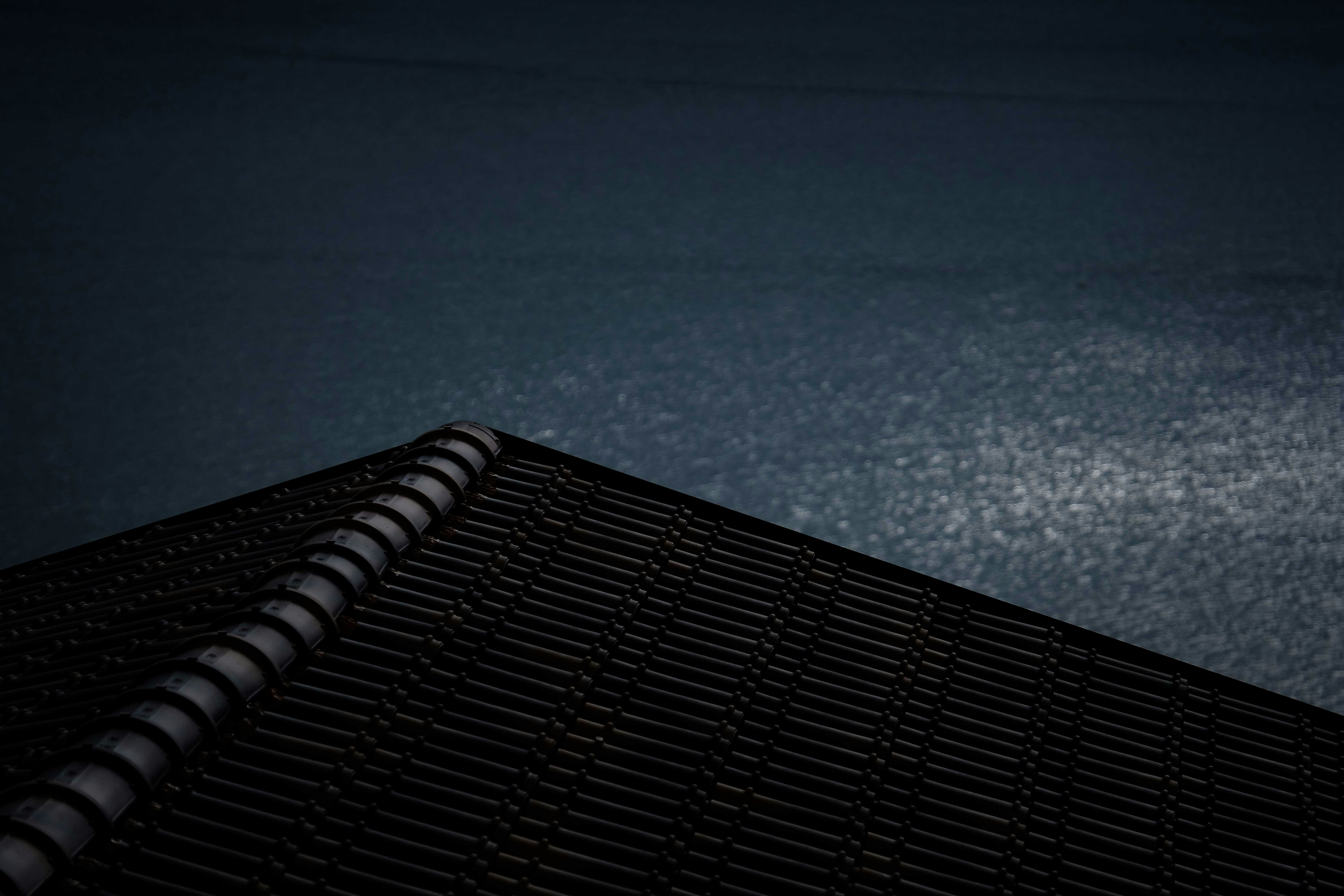 Ribbed Dock at Dusk: A Quiet Texture of Metal and Water