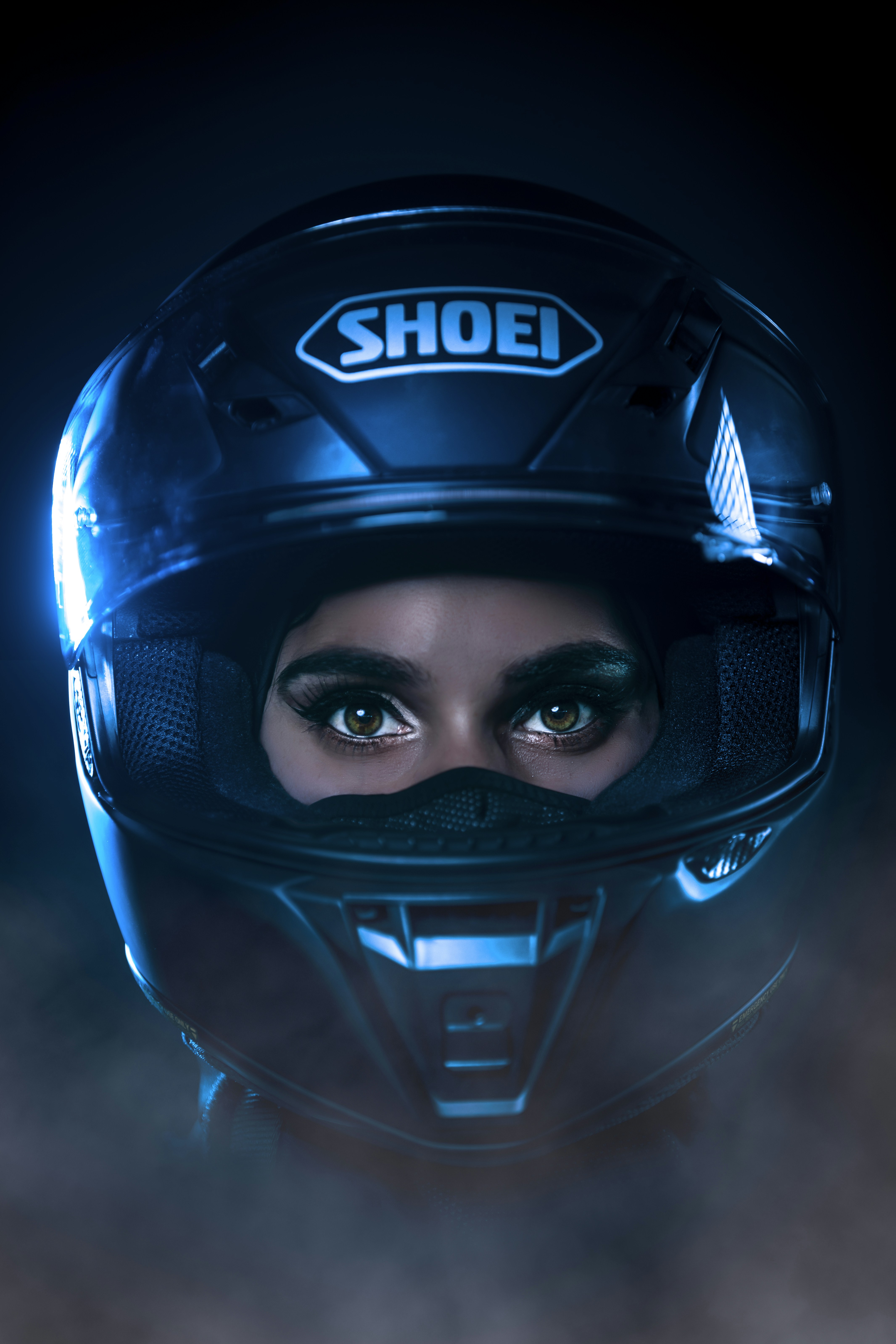 Oana in studio @jawfox.photography | black and blue helmet on black surface