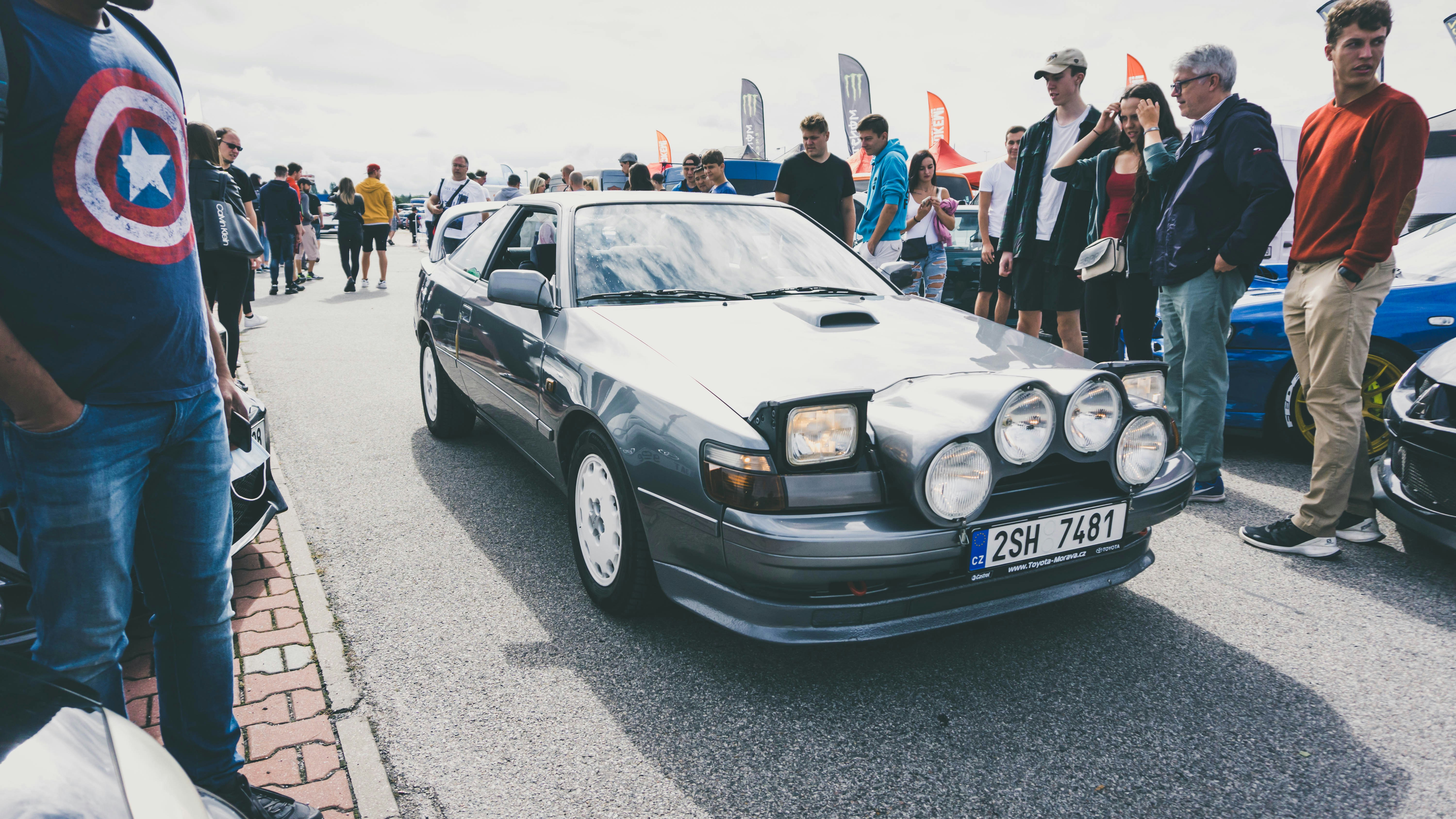 Retro Rally Stance: A Sporty Classic Under Parade Lights