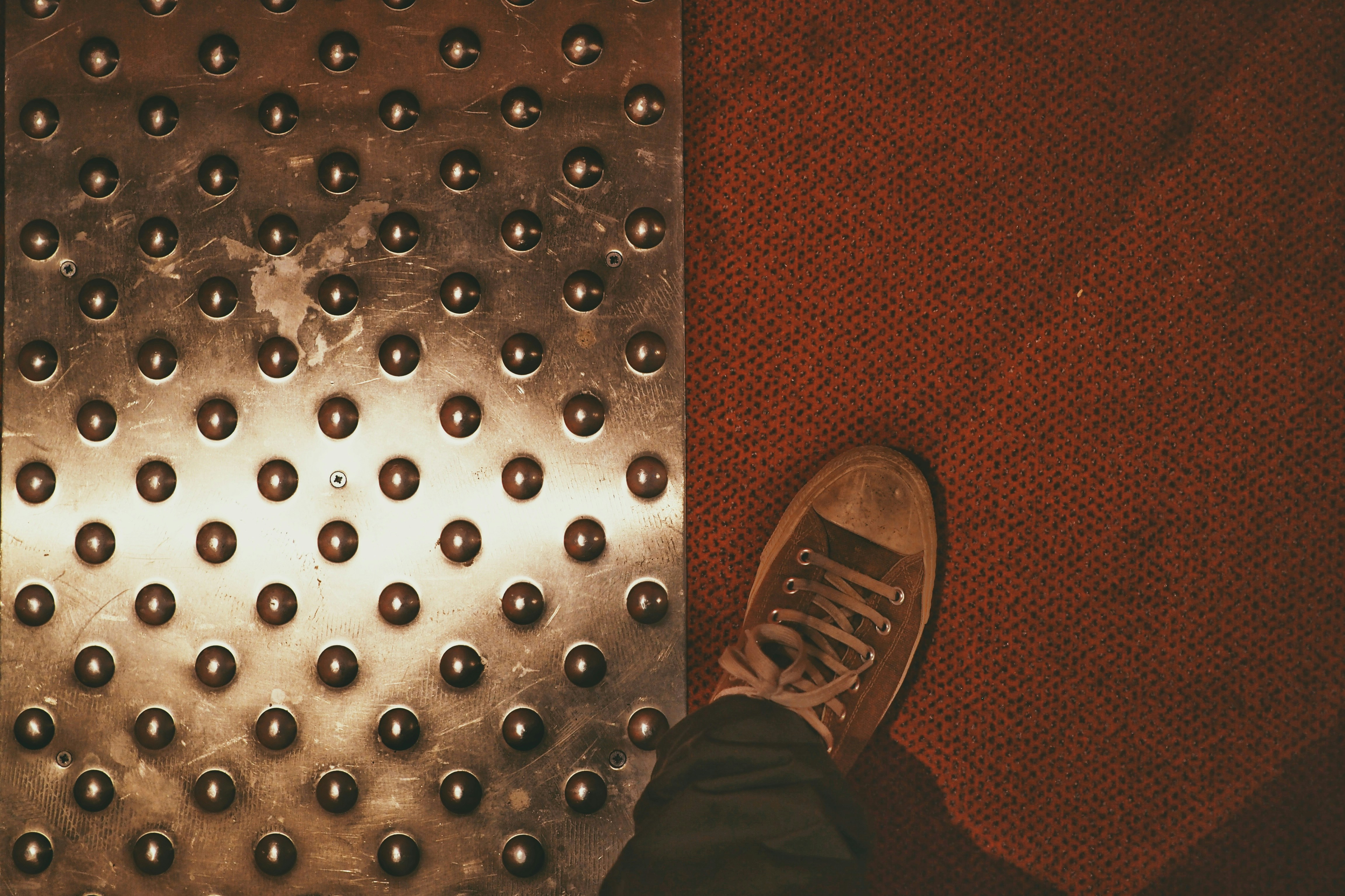 Footfall at the Threshold: Metal Studs Meet Red Carpet