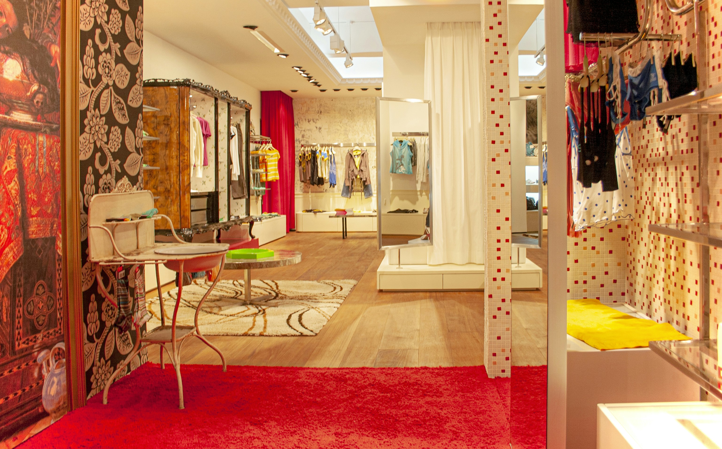 Fashion retail space featuring colorful displays, stylish clothing, and an inviting atmosphere. The layout encourages exploration and interaction.