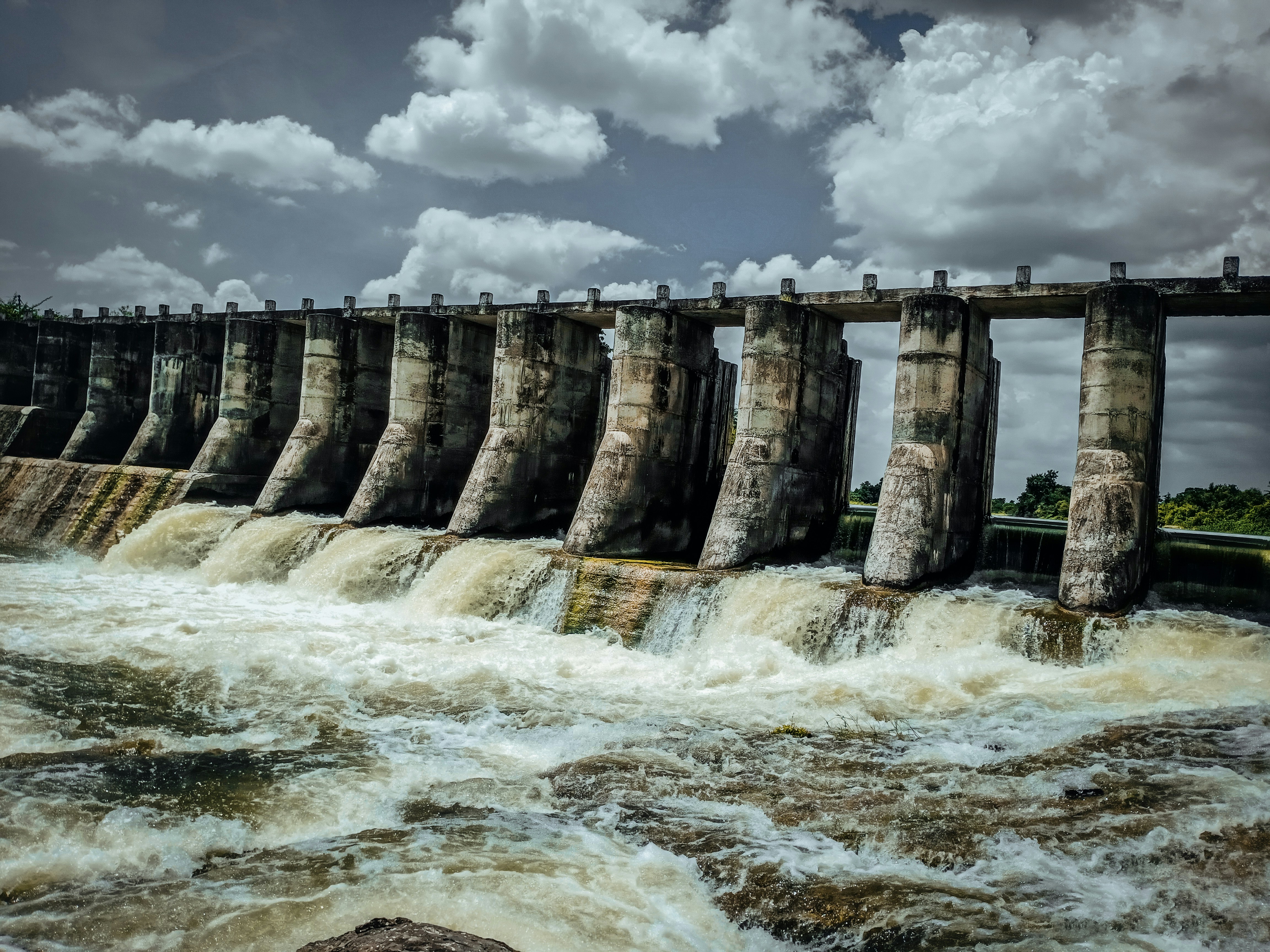 Spillway Lines Across the Dam Under a Cloudy Sky