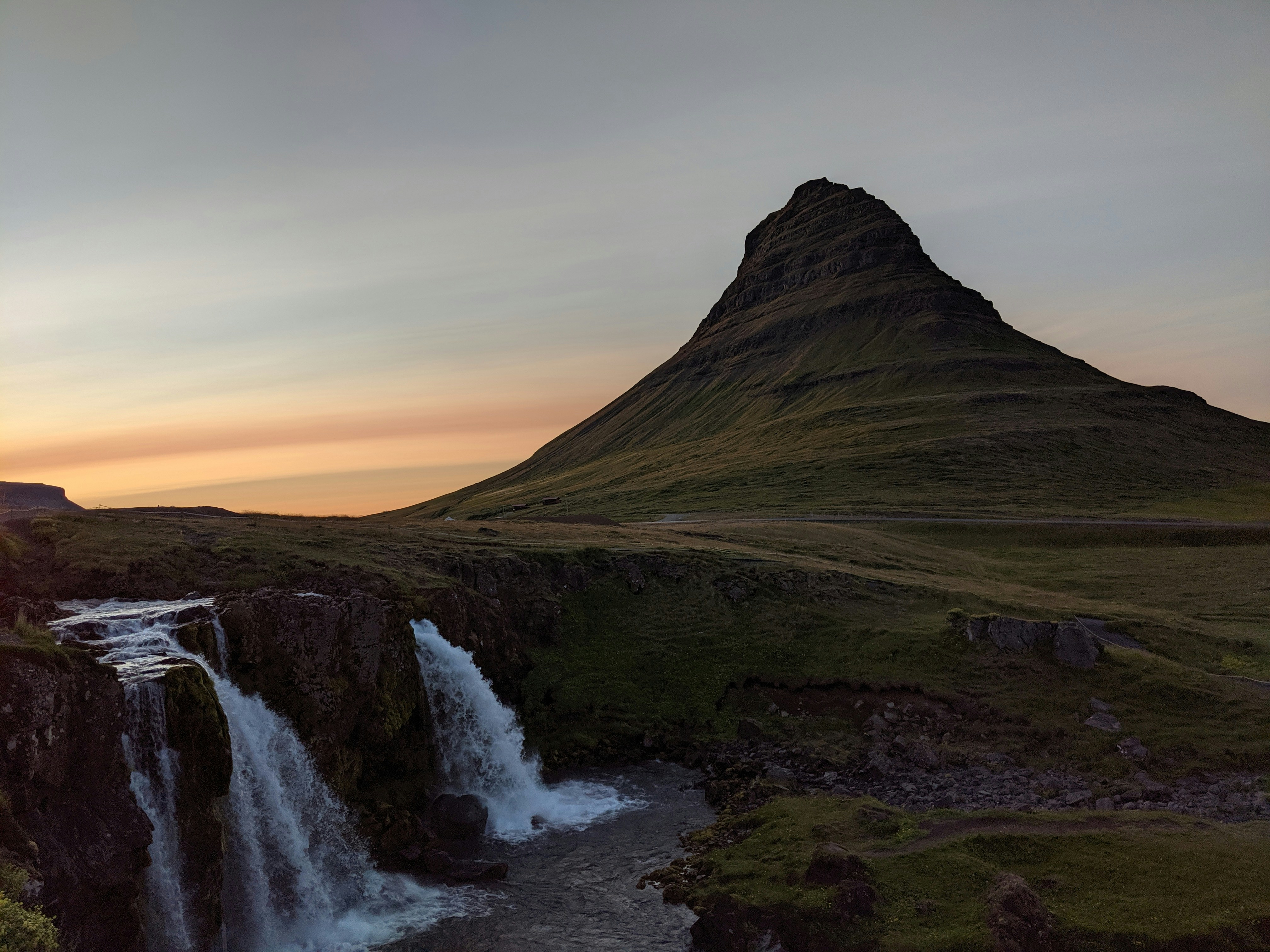 Waterfalls near green grass field and mountain during daytime photo ...