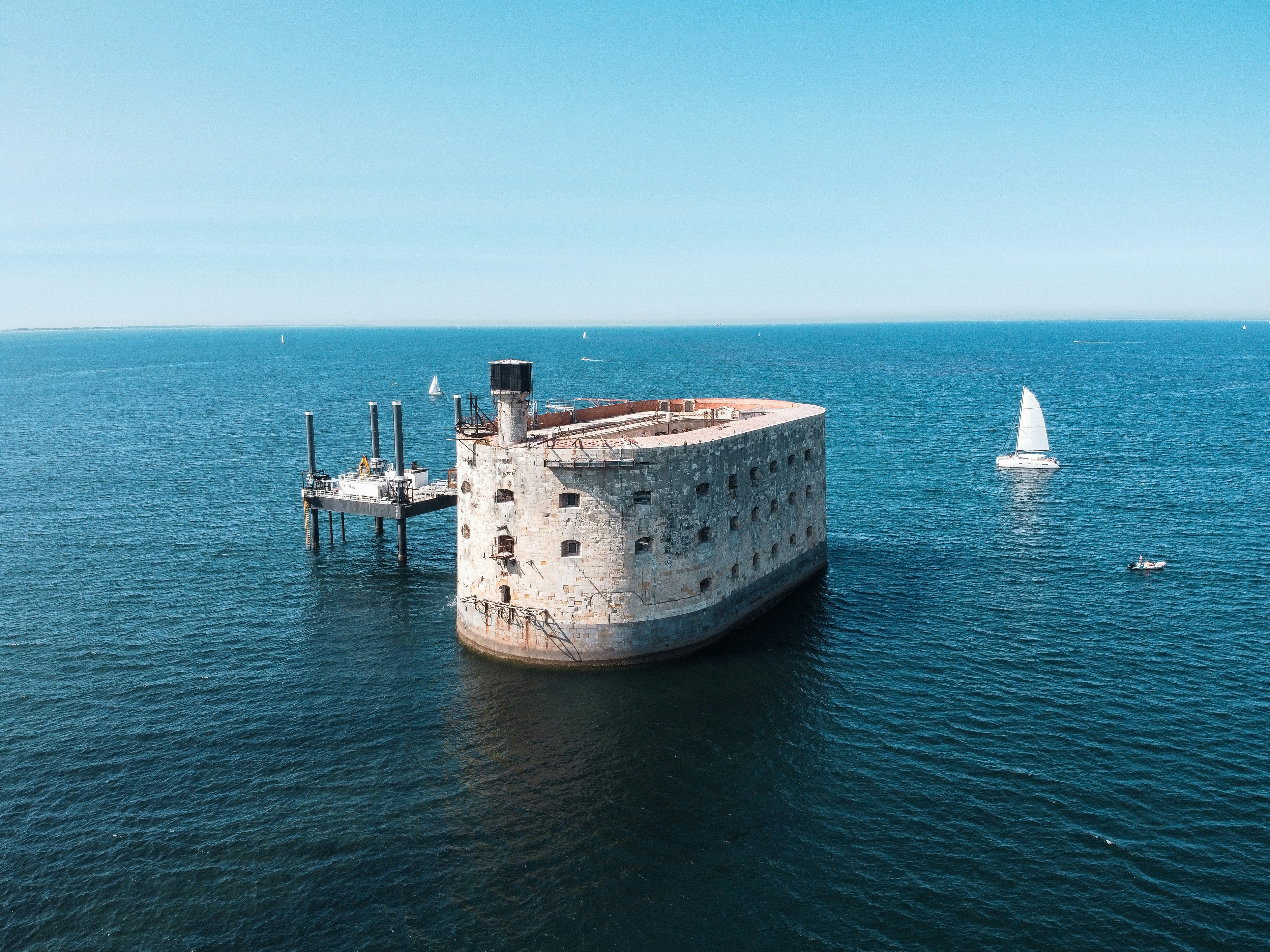 Round Fort at Sea: A Stone Sentinel Amid Calm Blue