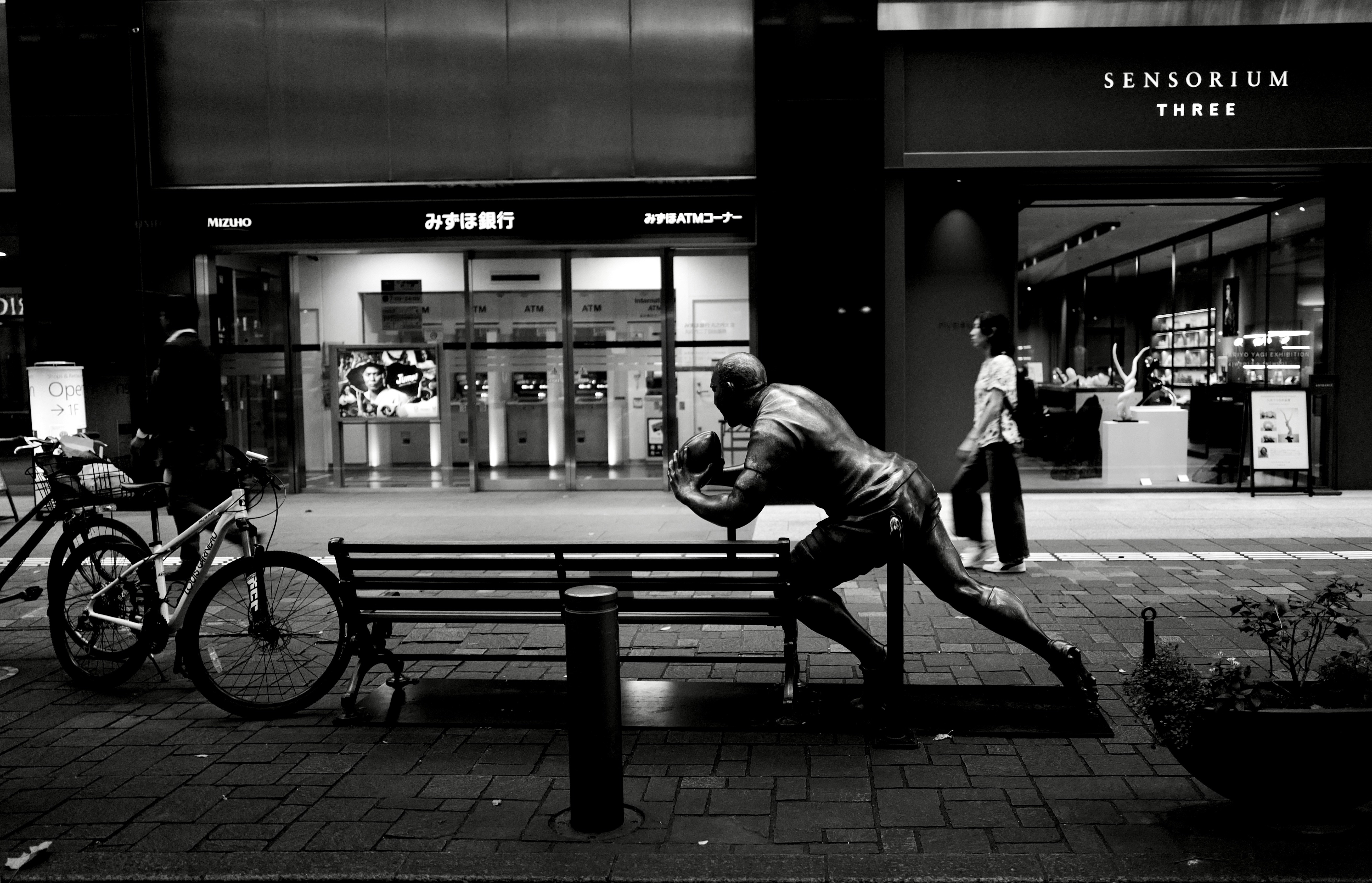 Bench-Lunge on Neon Street: A Monochrome Moment
