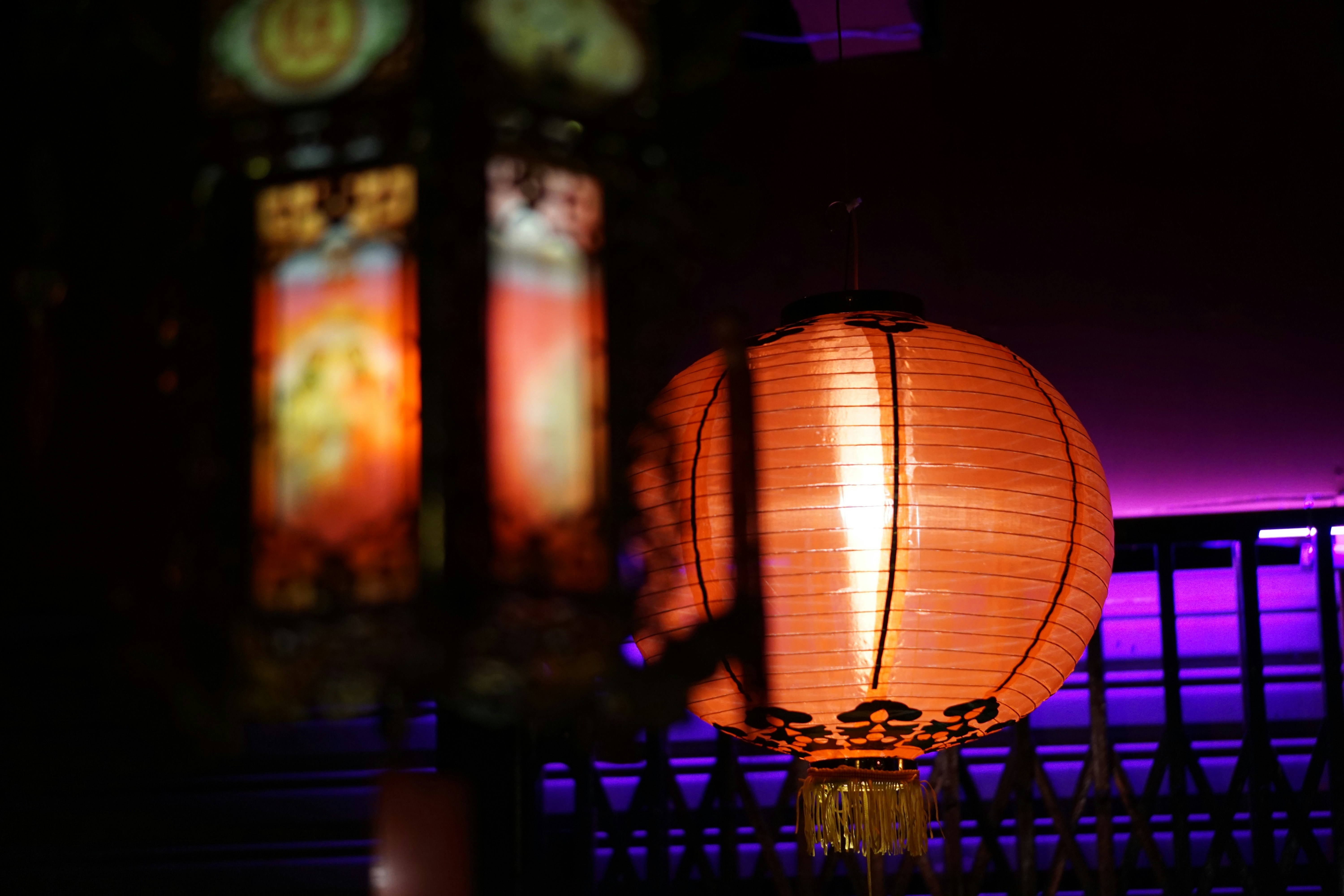 Glowing Lantern in a Night Market Corridor