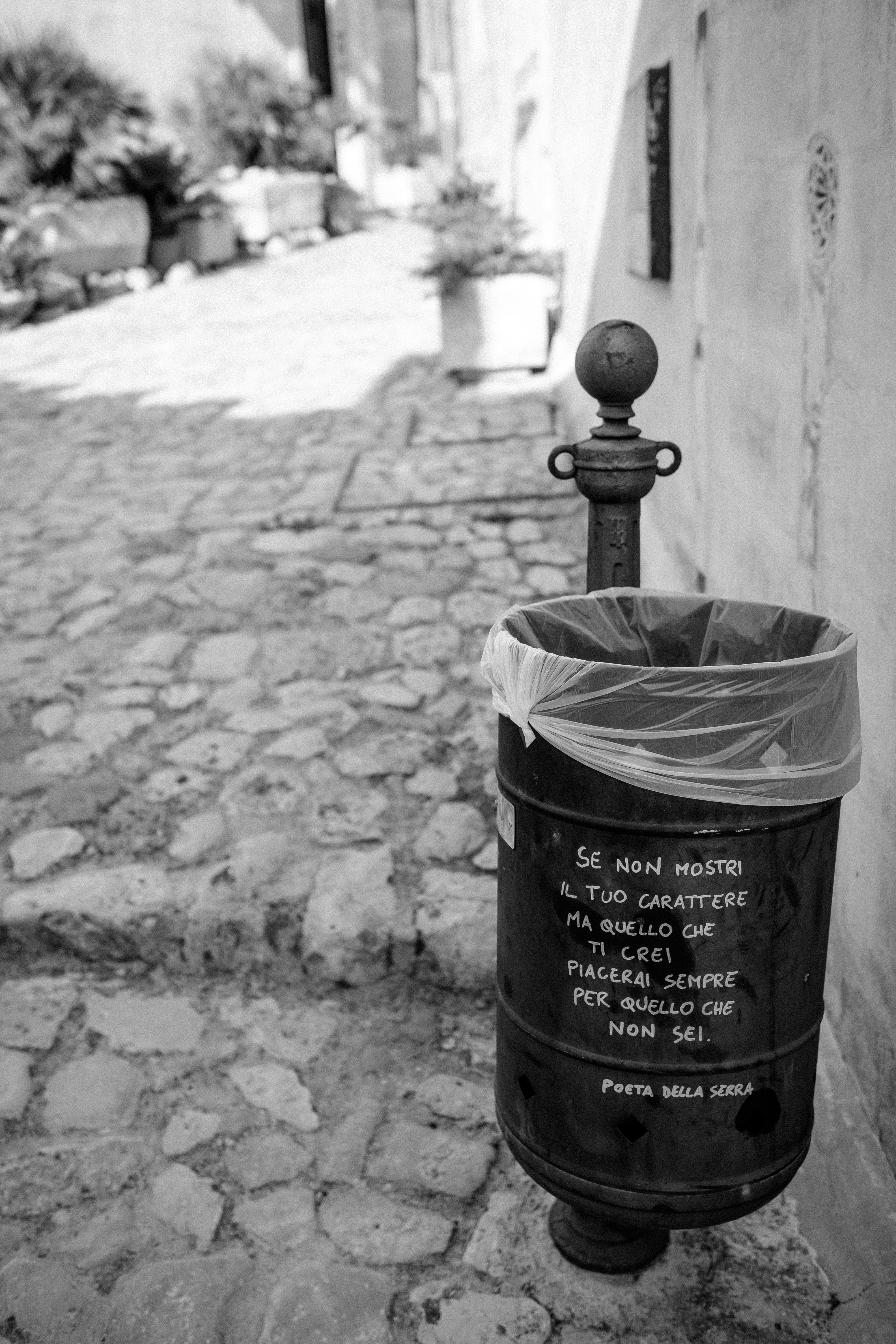 Urban Verve: A Quiet Street Trashcan with Poetic Imprint