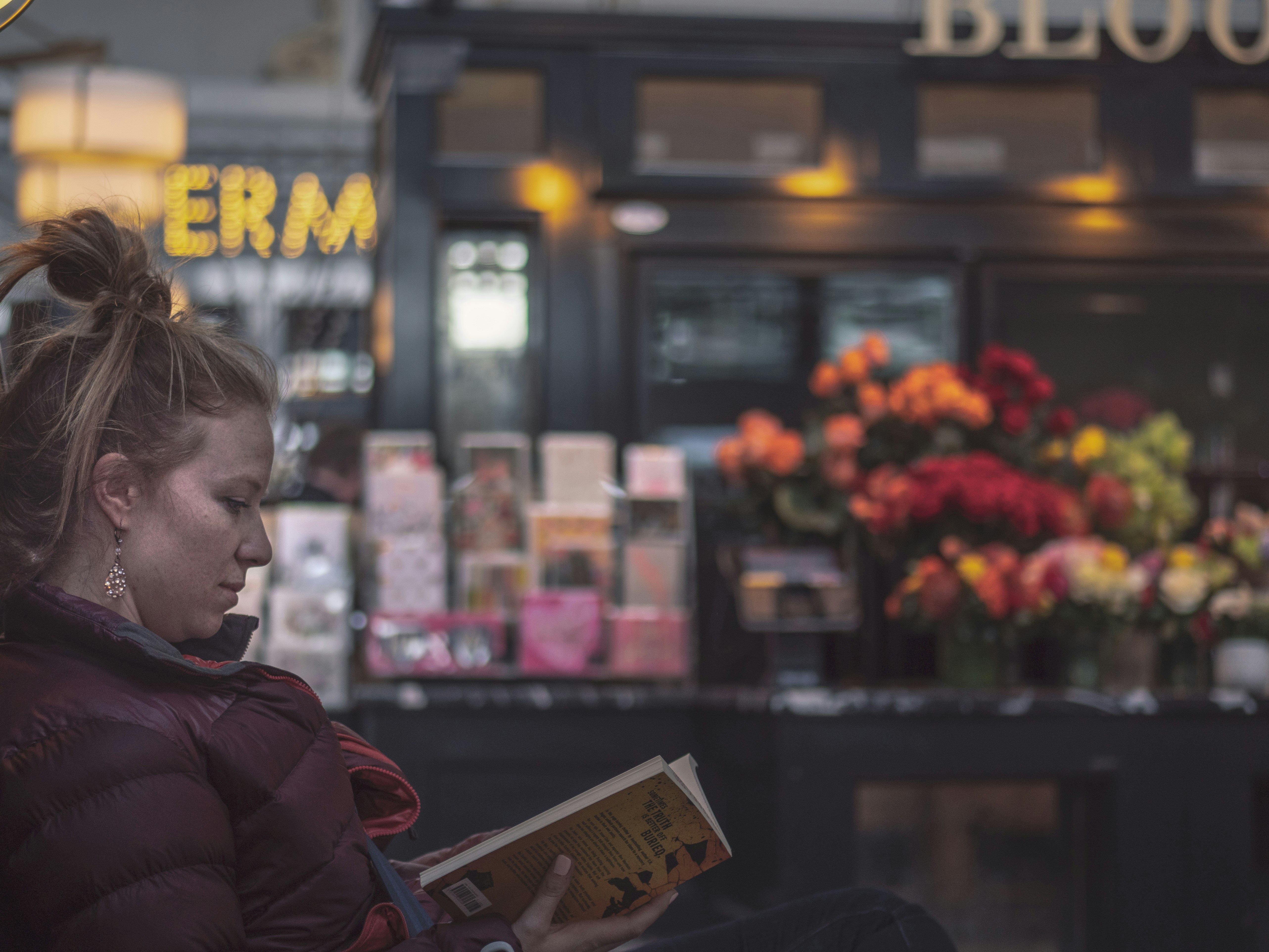 Reading by Bloom-lit Street: A Quiet City Moment