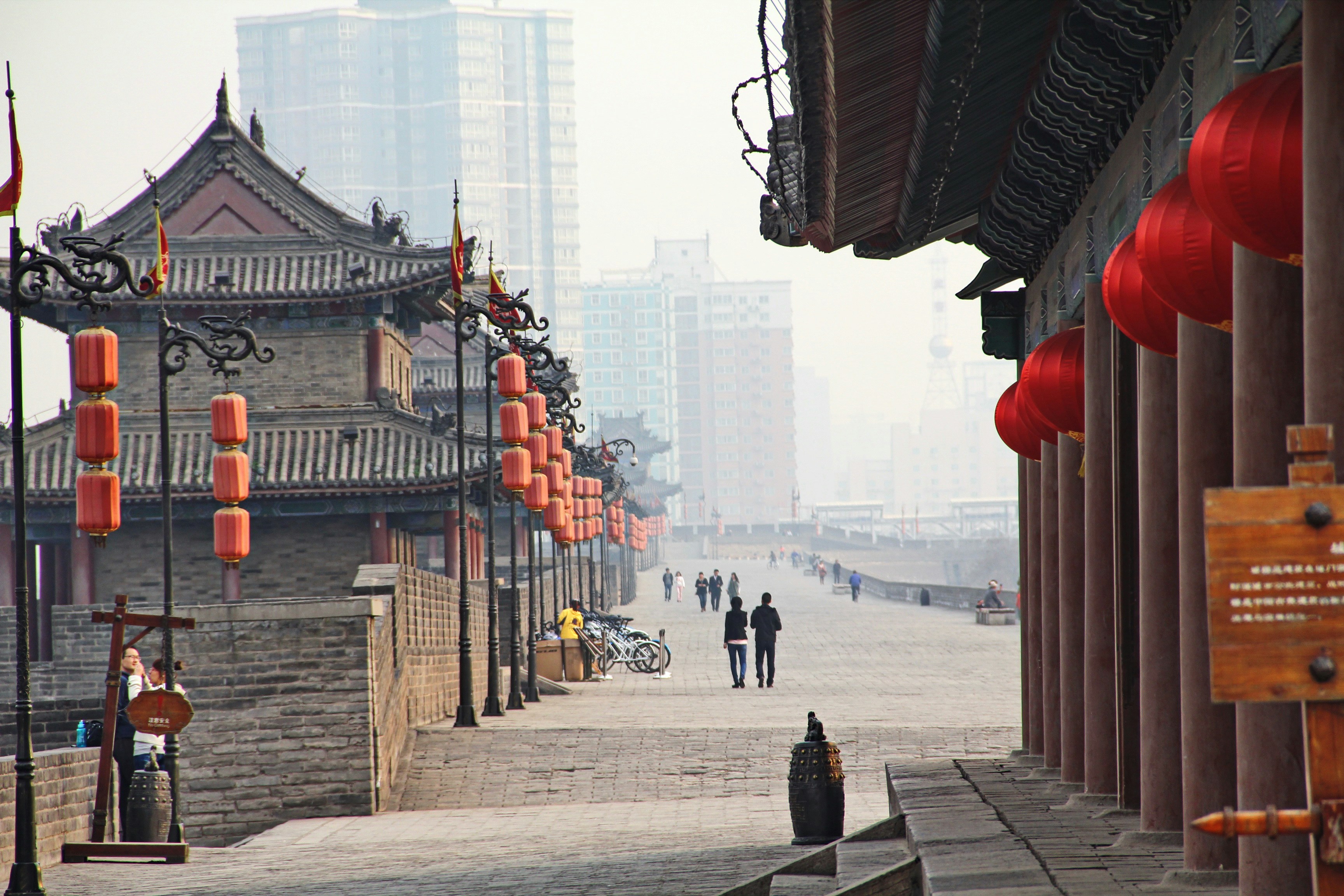 Lantern-Lined Heritage Alley Toward a Distant Skyline