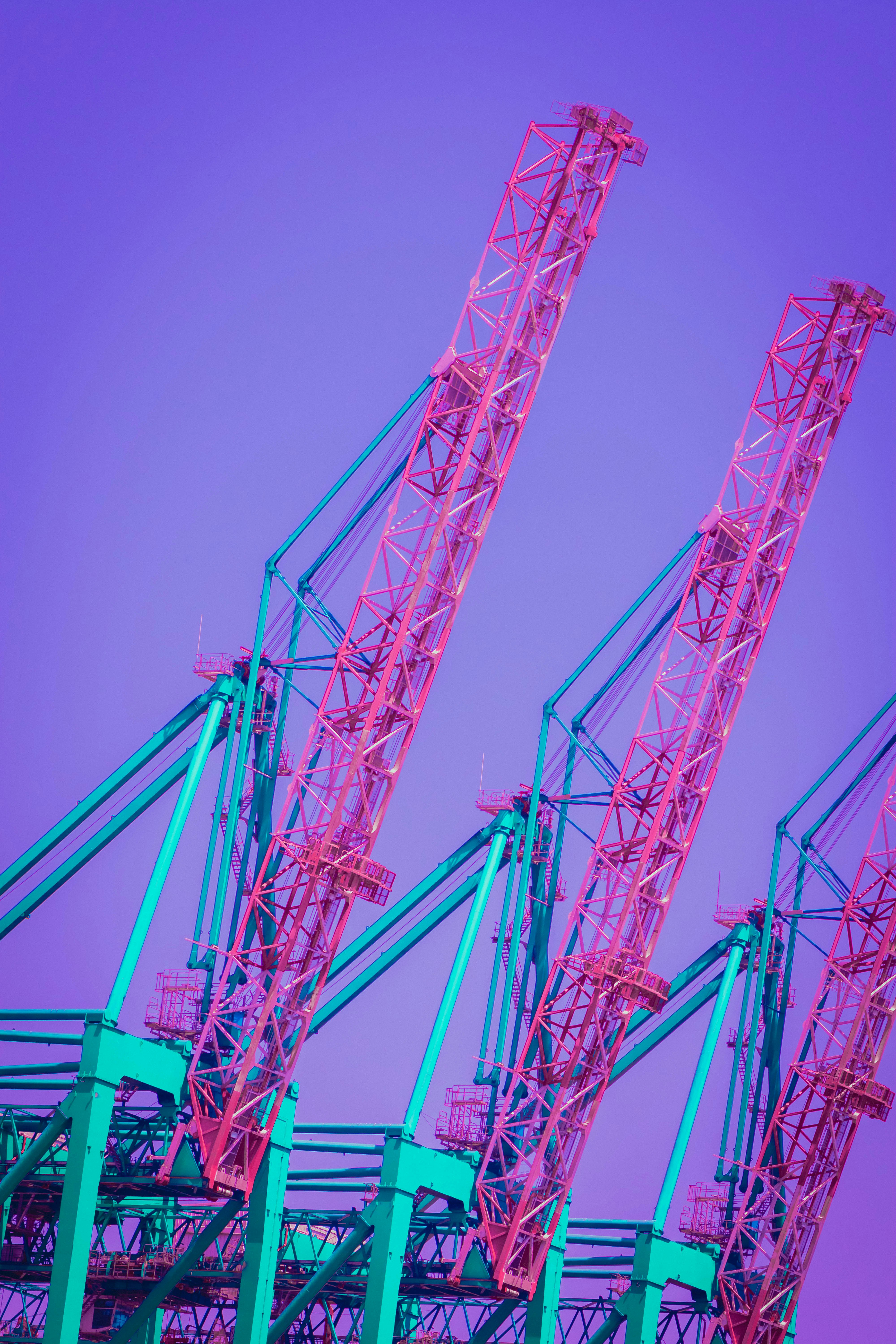 Neon Struts: Tilted Cranes Catch the Violet Sky