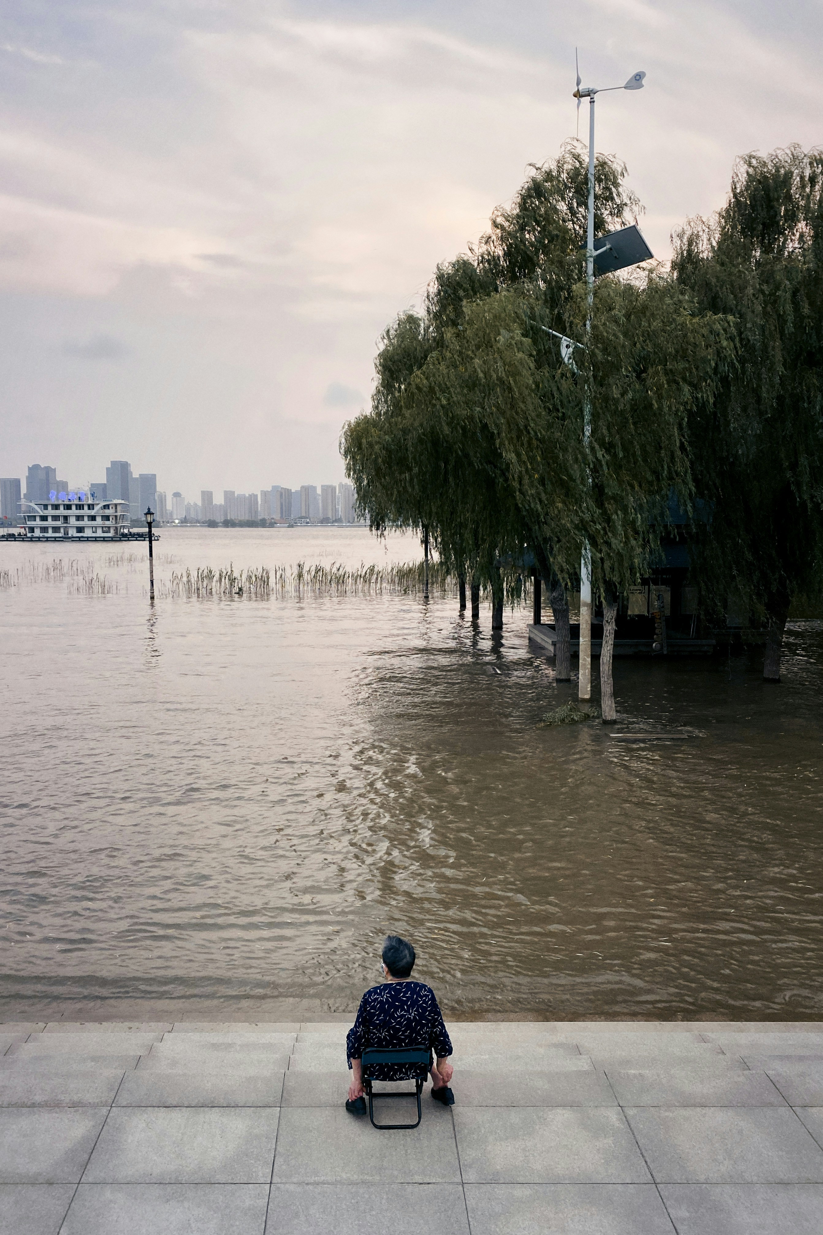 Lone Folding Chair by Rising Waters, Facing the Urban Horizon