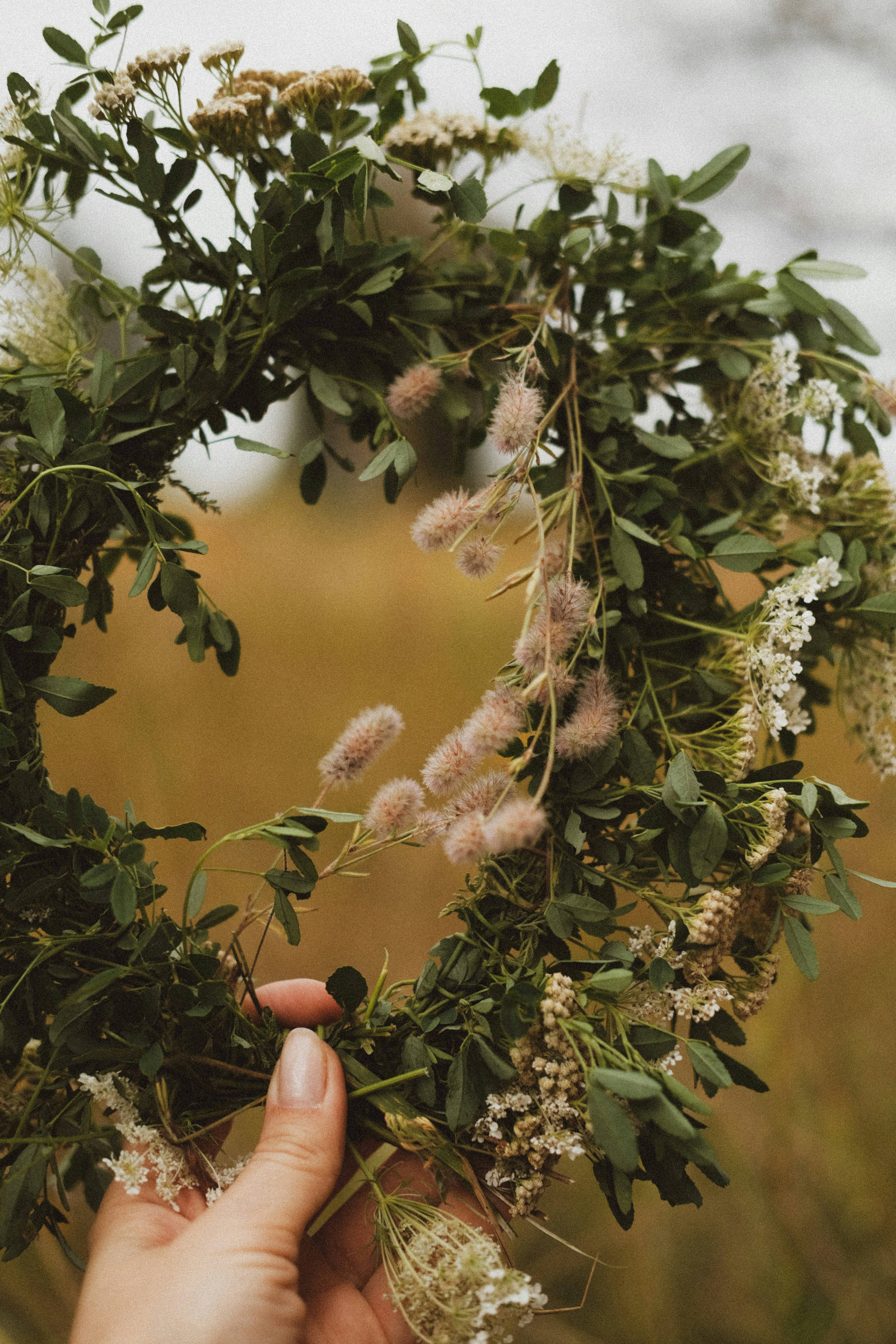 Hand-Held Wreath of Soft Blooms in a Golden Field