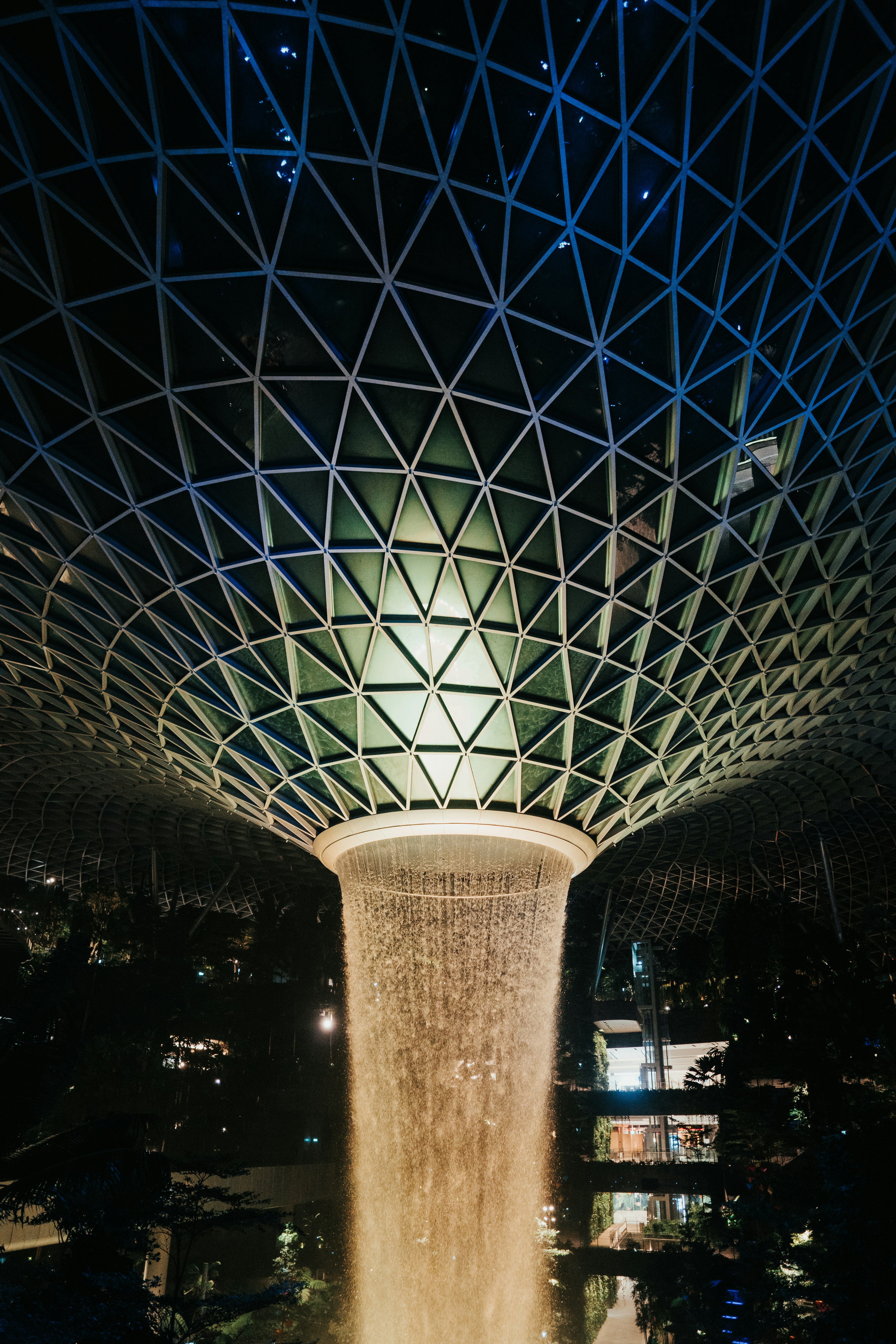 Cascading Light Under a Geometric Dome: Nightfall at the Waterfall Atrium