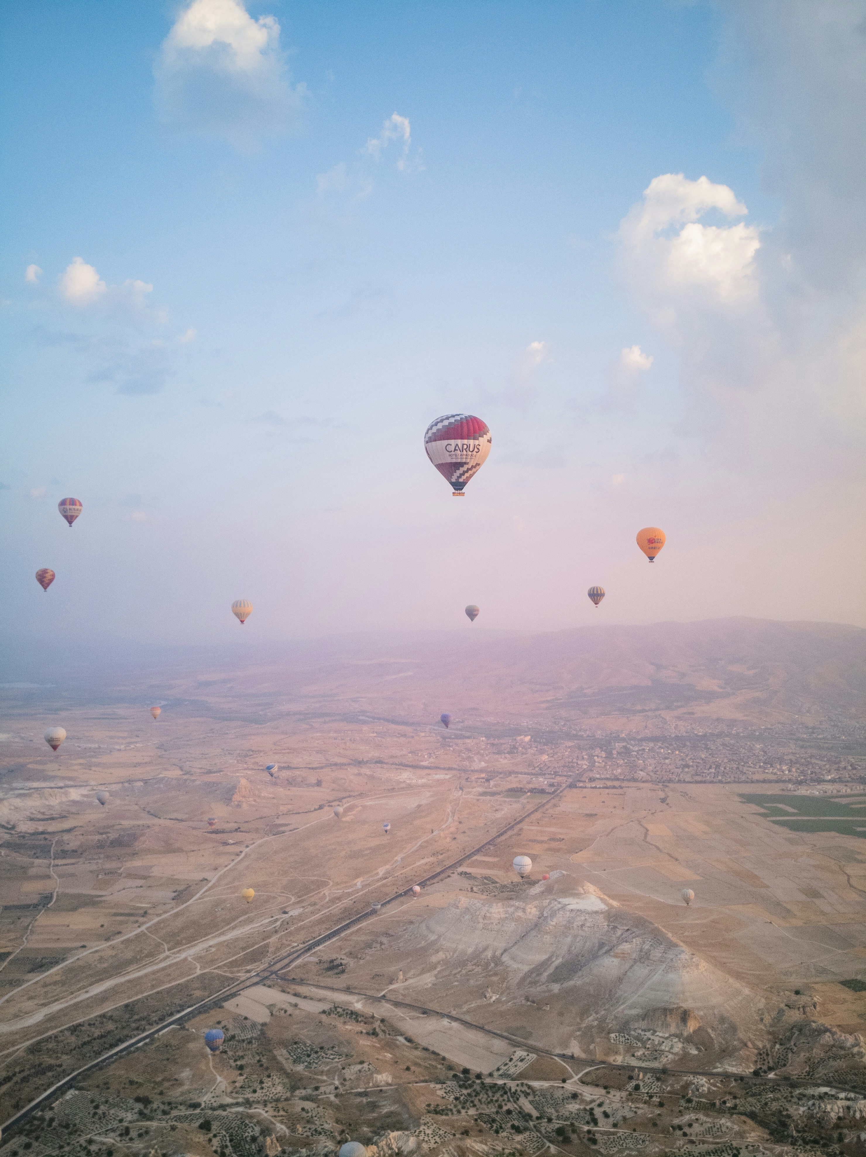 Dawn Drift: A Quiet Sky Full of Balloons Over a Desert Valley