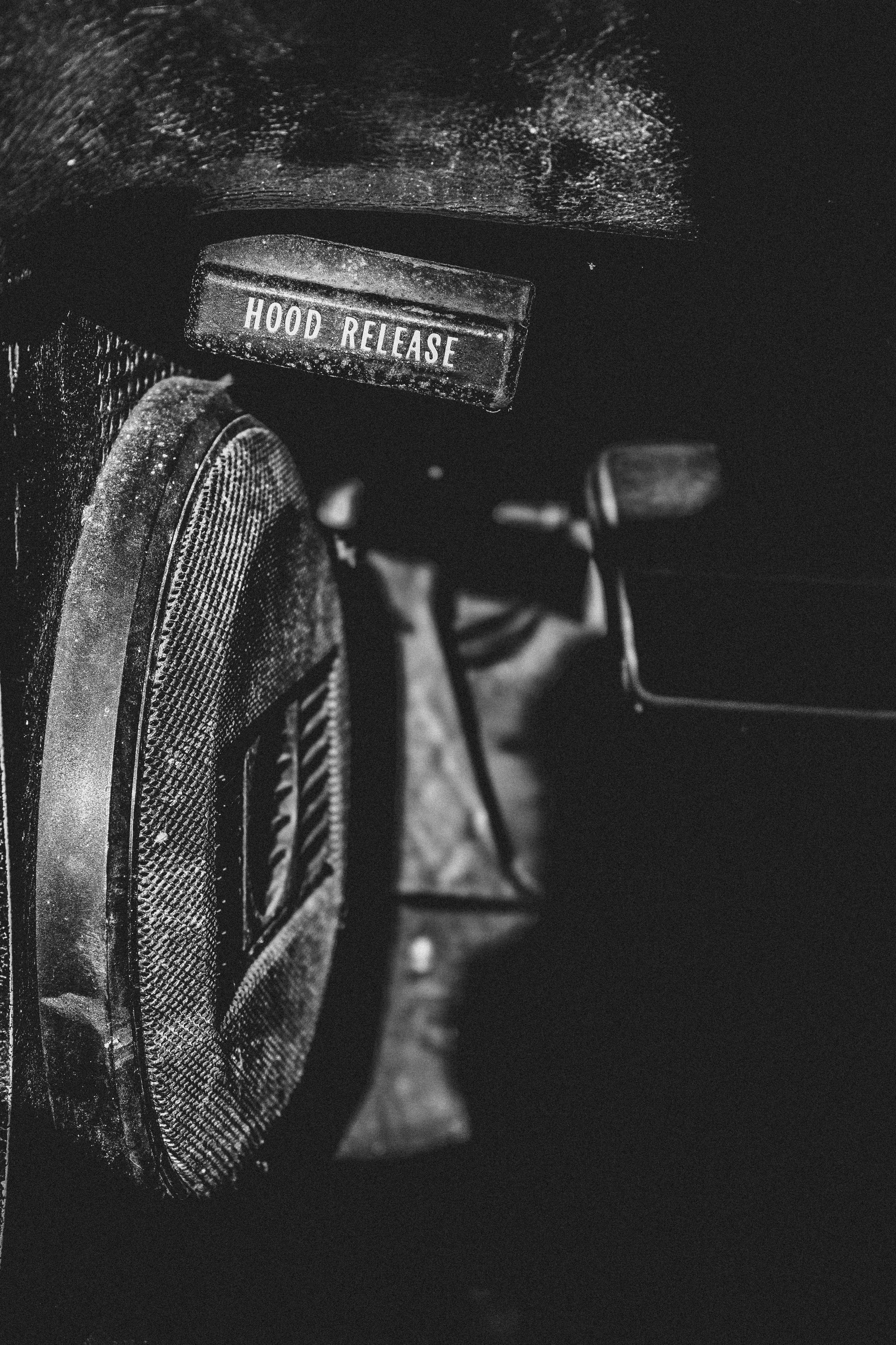 Aged Steel and Silence: Close-Up of a Vintage Hood-Release Lever