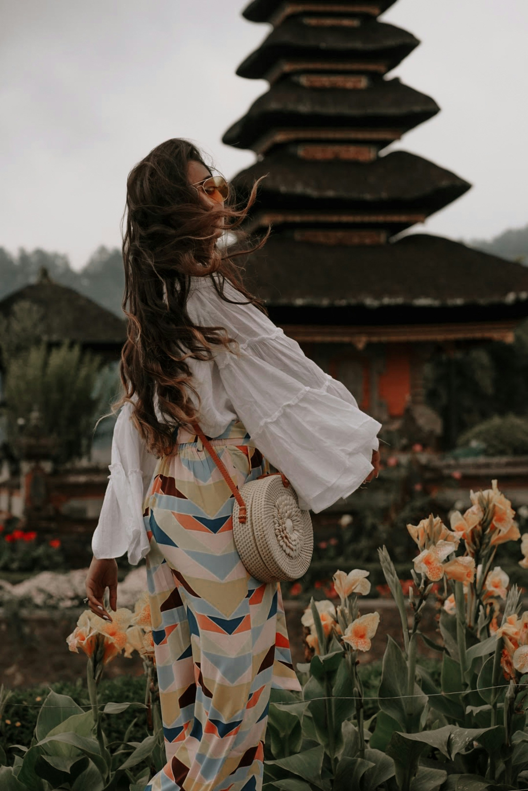 Wind-Tossed Portrait Among Tulips with a Stacked-Tier Pagoda in the Background