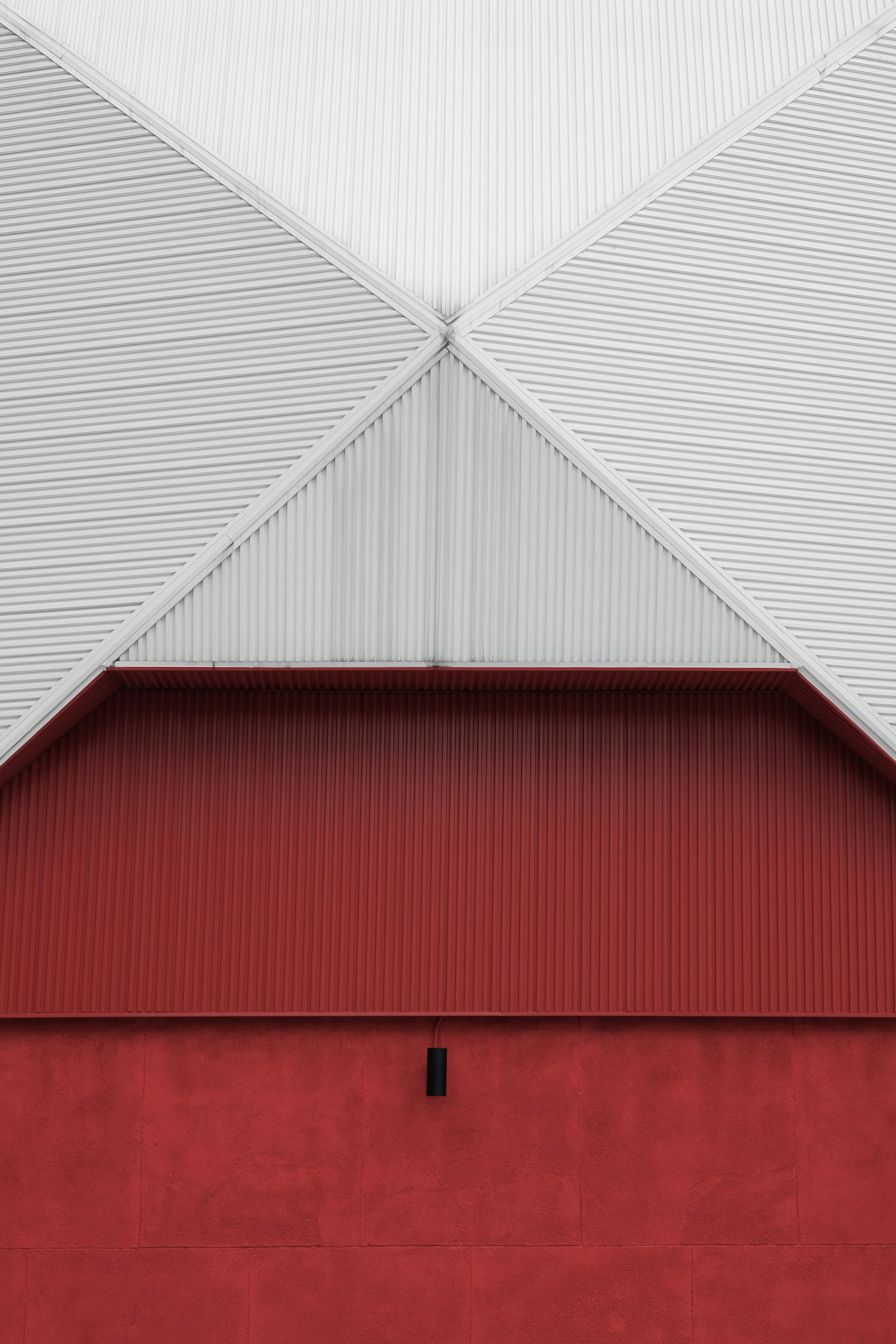 Diamond Confluence: White Triangles Converge Over a Crimson Facade