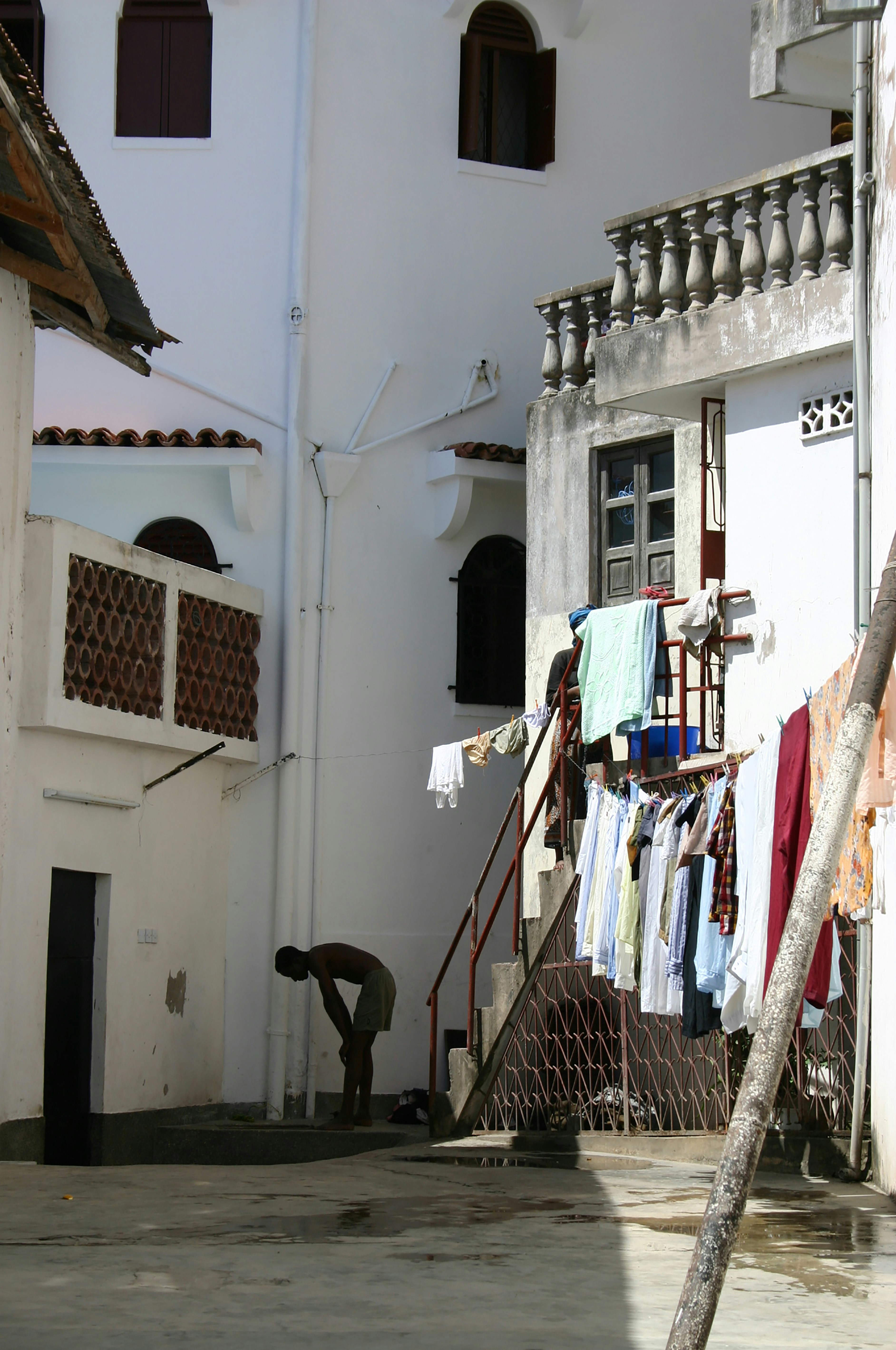 Sunlit Laundry on a Staircase: Color Between White Facades