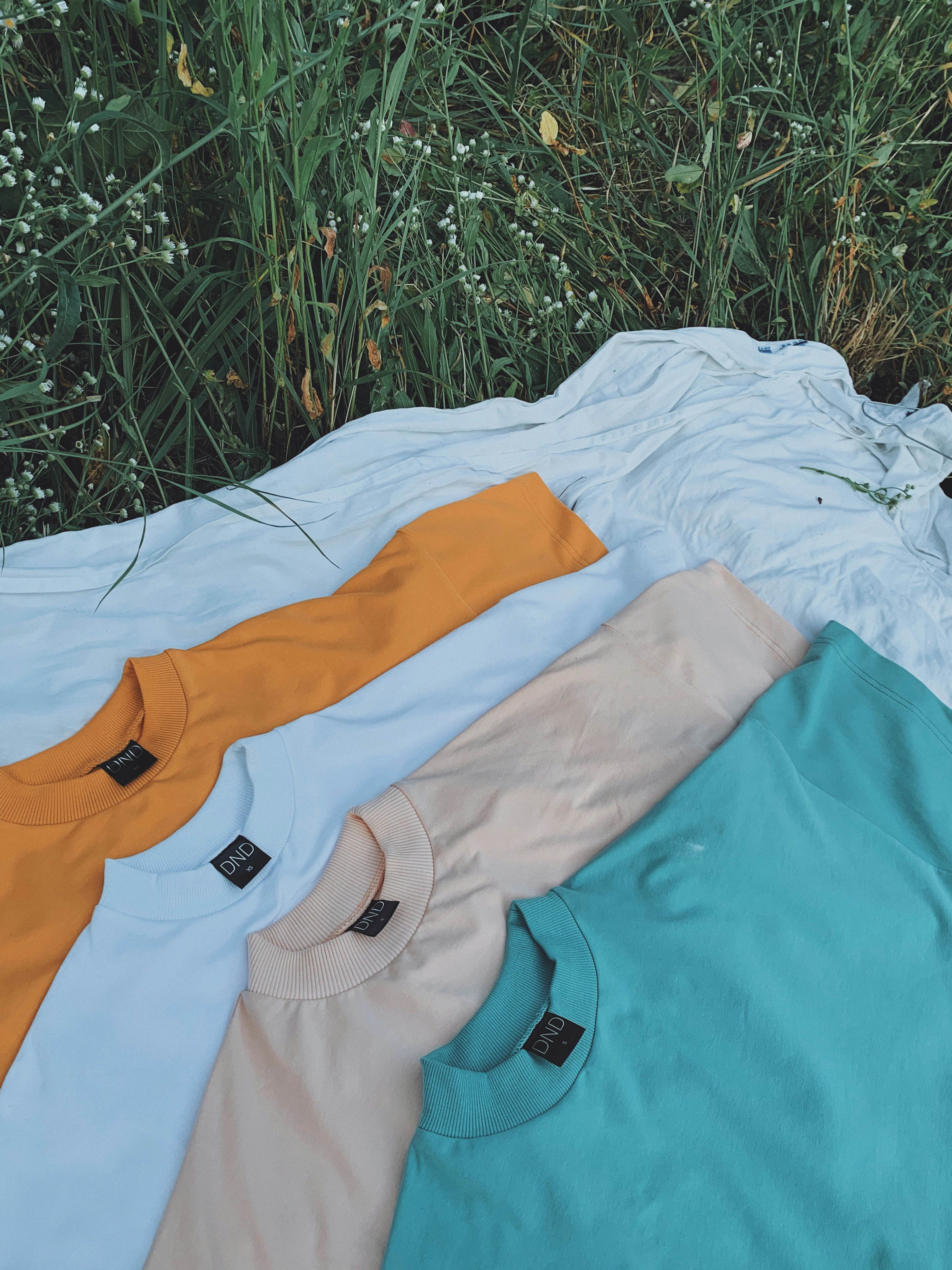 Pastel Wardrobe Spread on Grass: A Quiet Outdoor Fabric Display