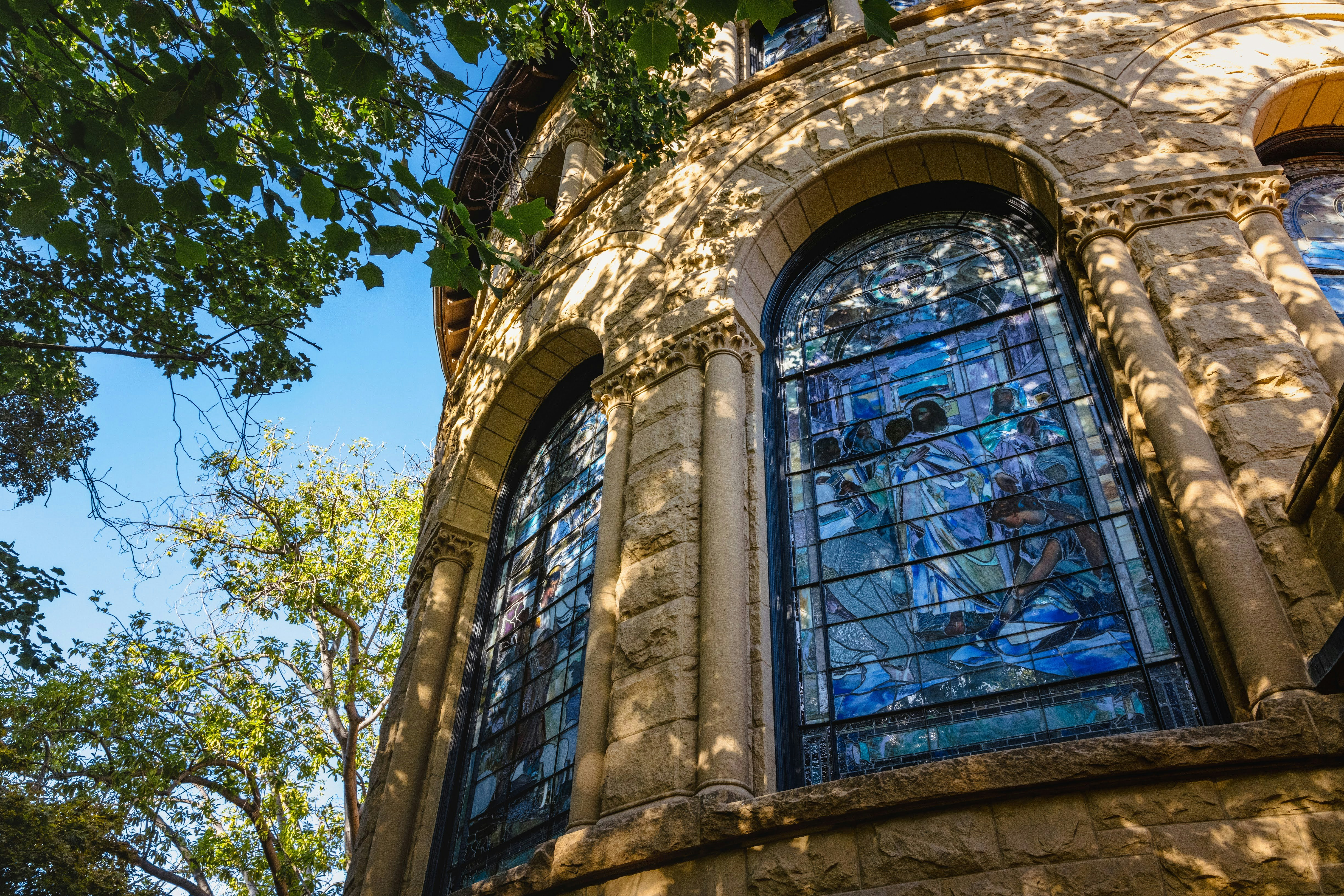 Blue glass window on brown concrete building during daytime photo ...
