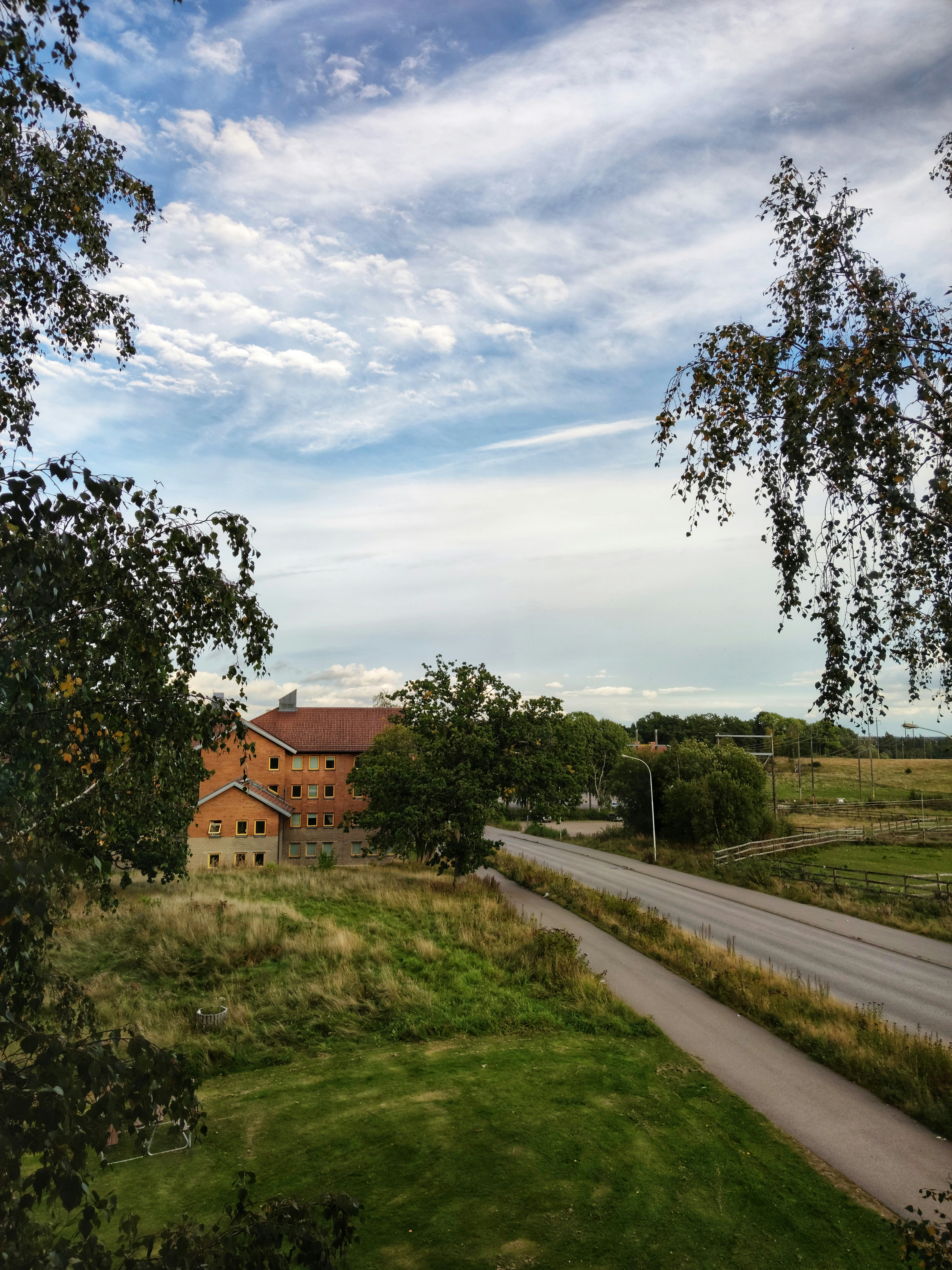 Red Brick Farmstead at the Turn of a Quiet Rural Road