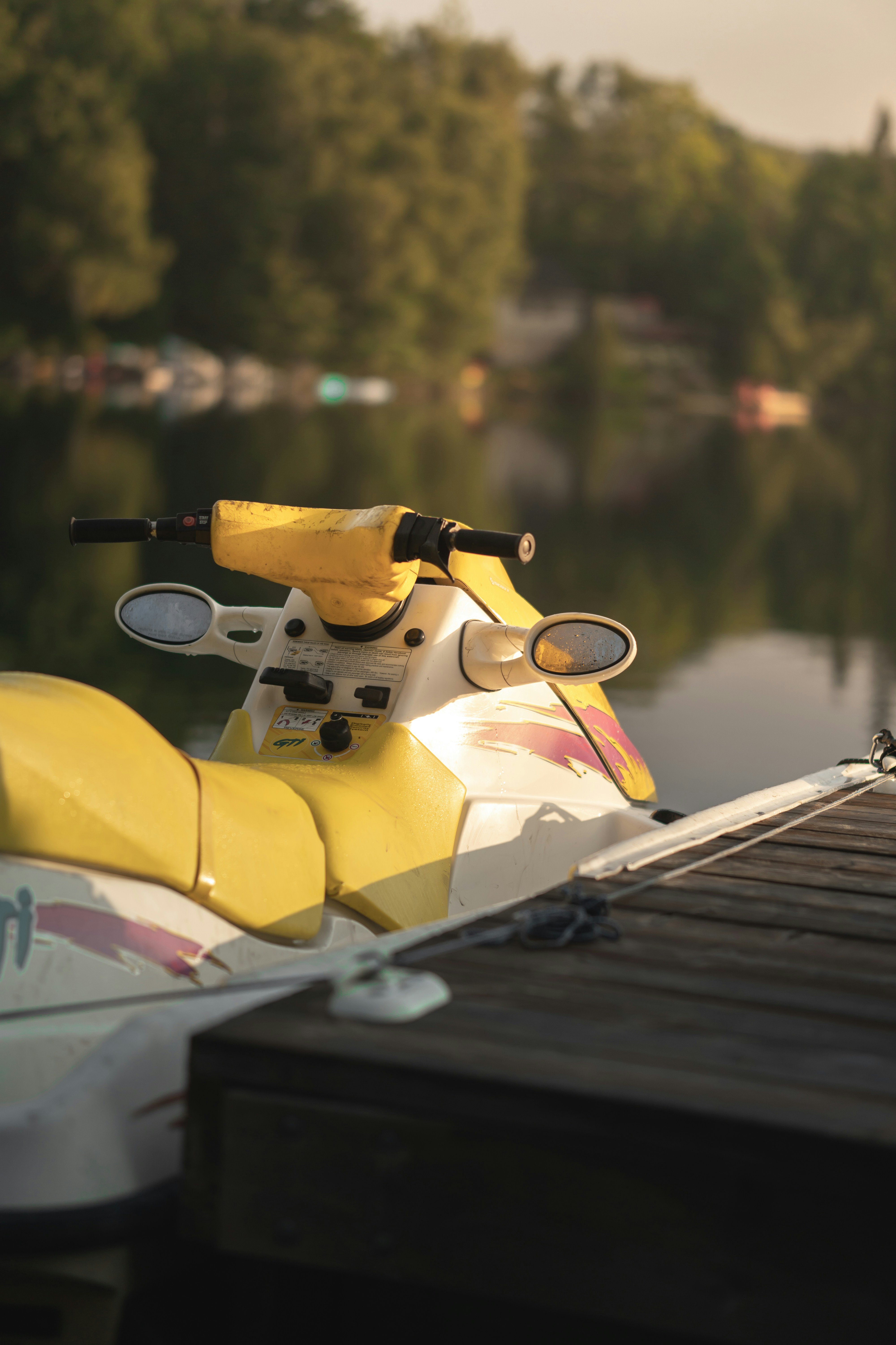 yellow and black motor scooter parked on dock during daytime