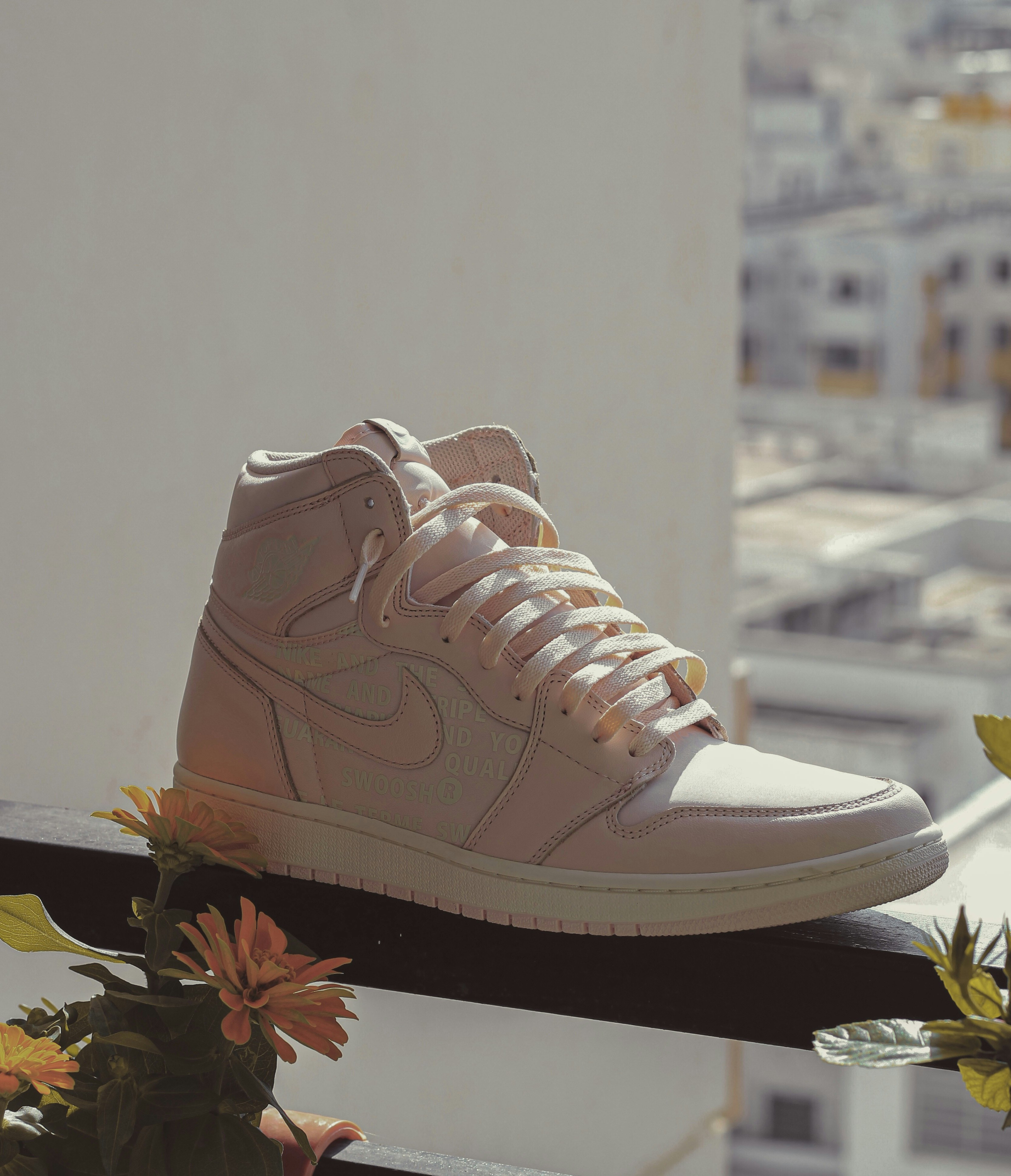 Pastel High: A Single Sneaker resting on a Balcony Railing