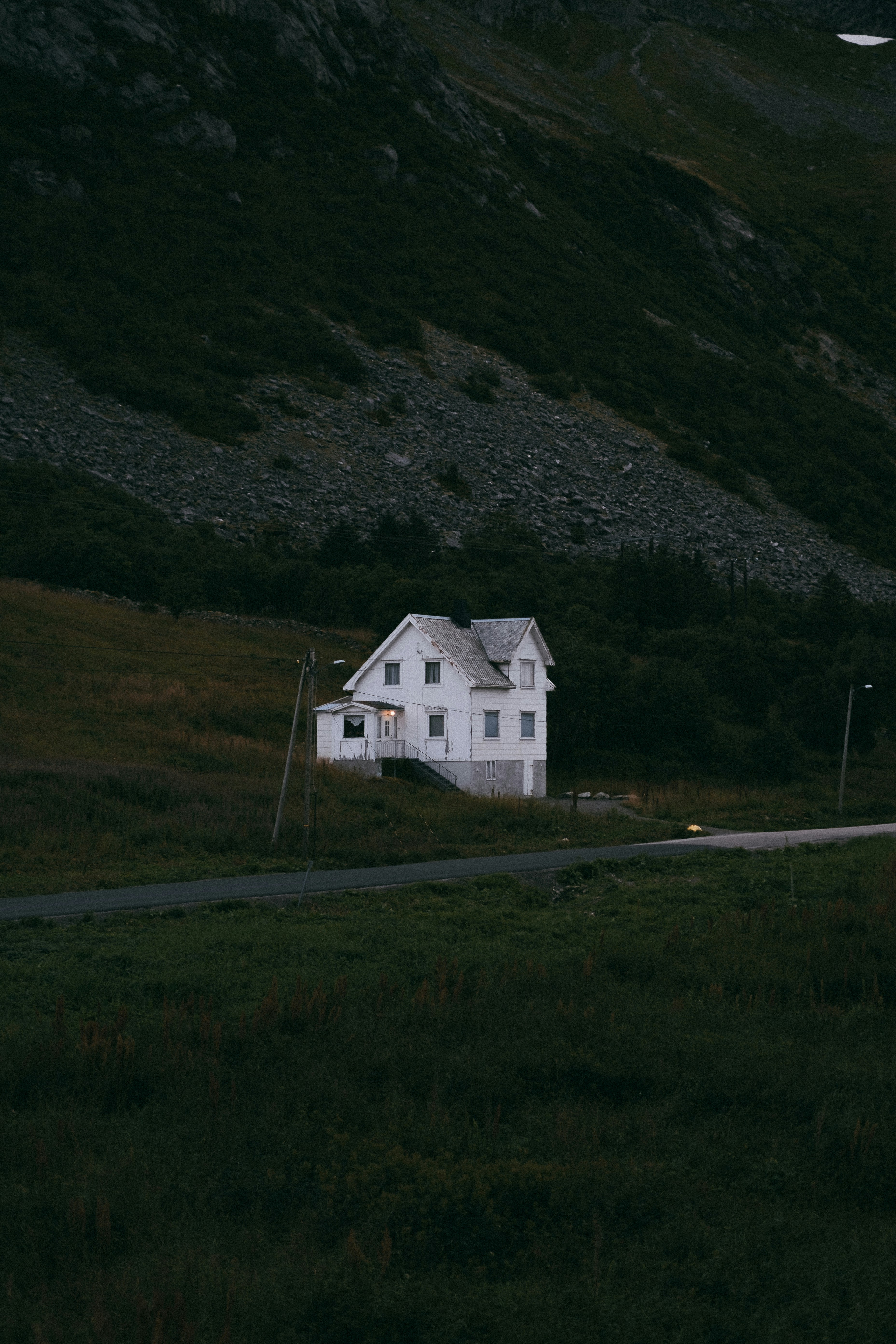 Solitary White House at the Foot of a Rugged Moor