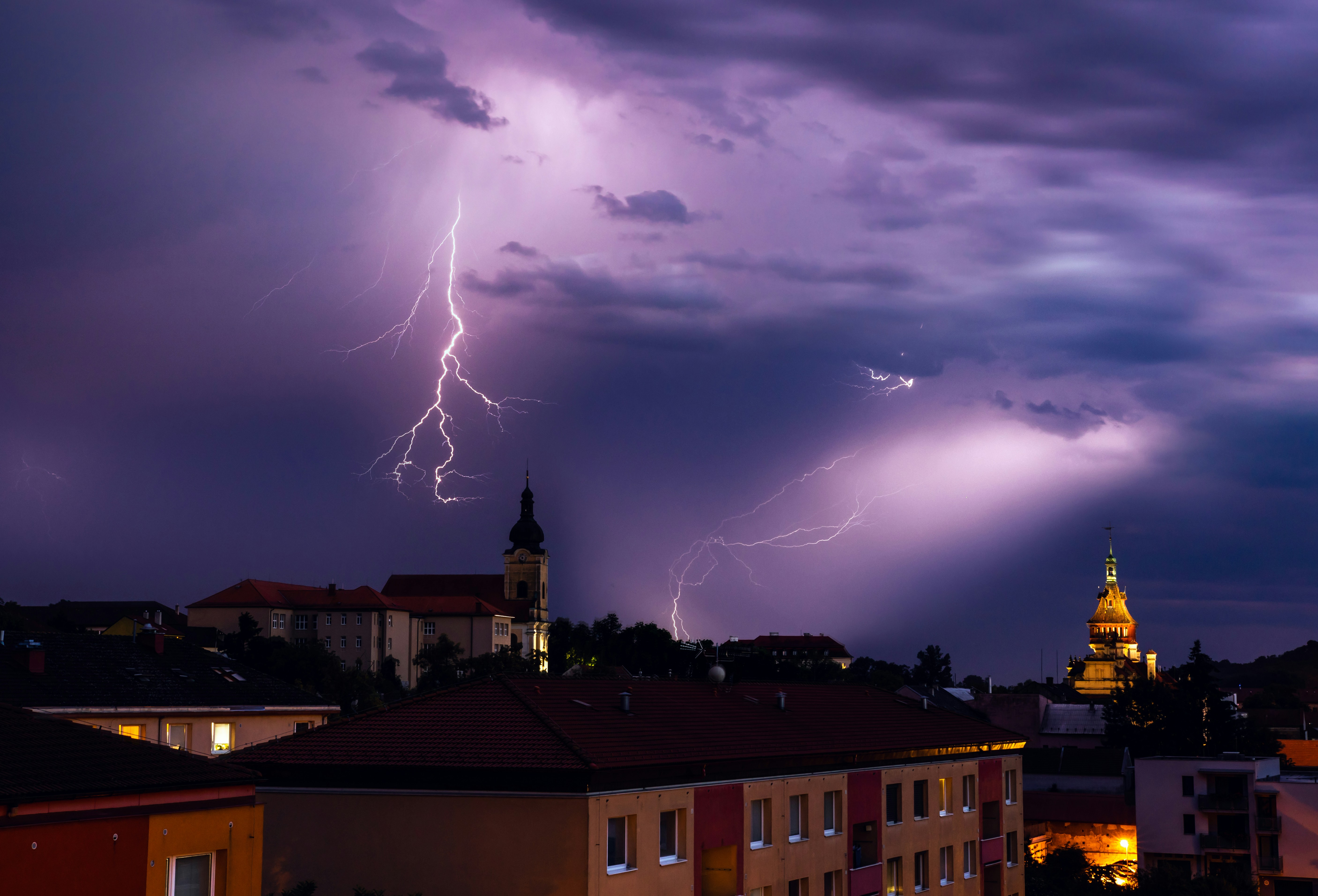 Lightning over a Quiet City: Nightfall Sparks the Horizon