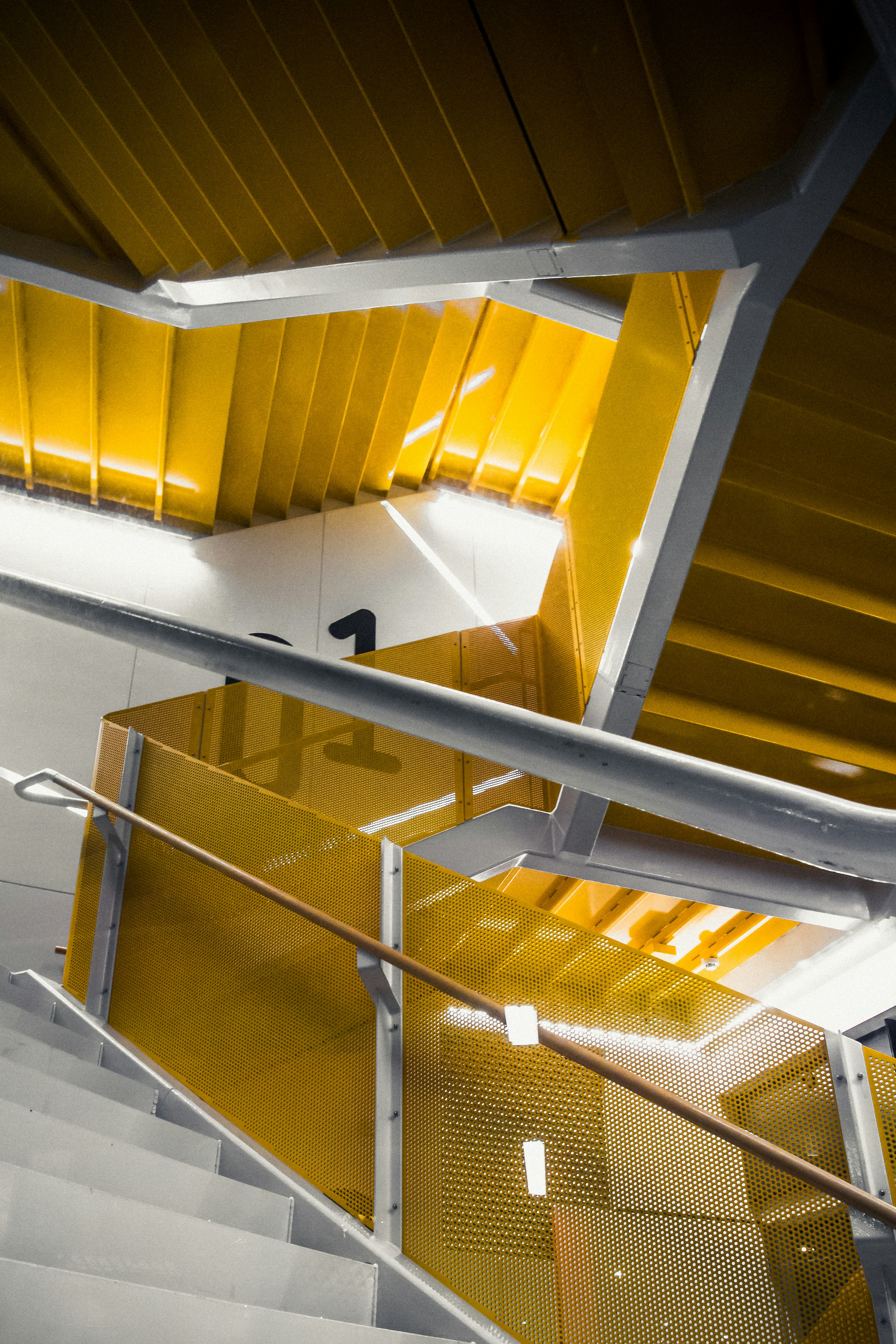 Intricate staircase design featuring bold yellow hues and modern architectural elements, emphasizing the interplay of lines and shapes.