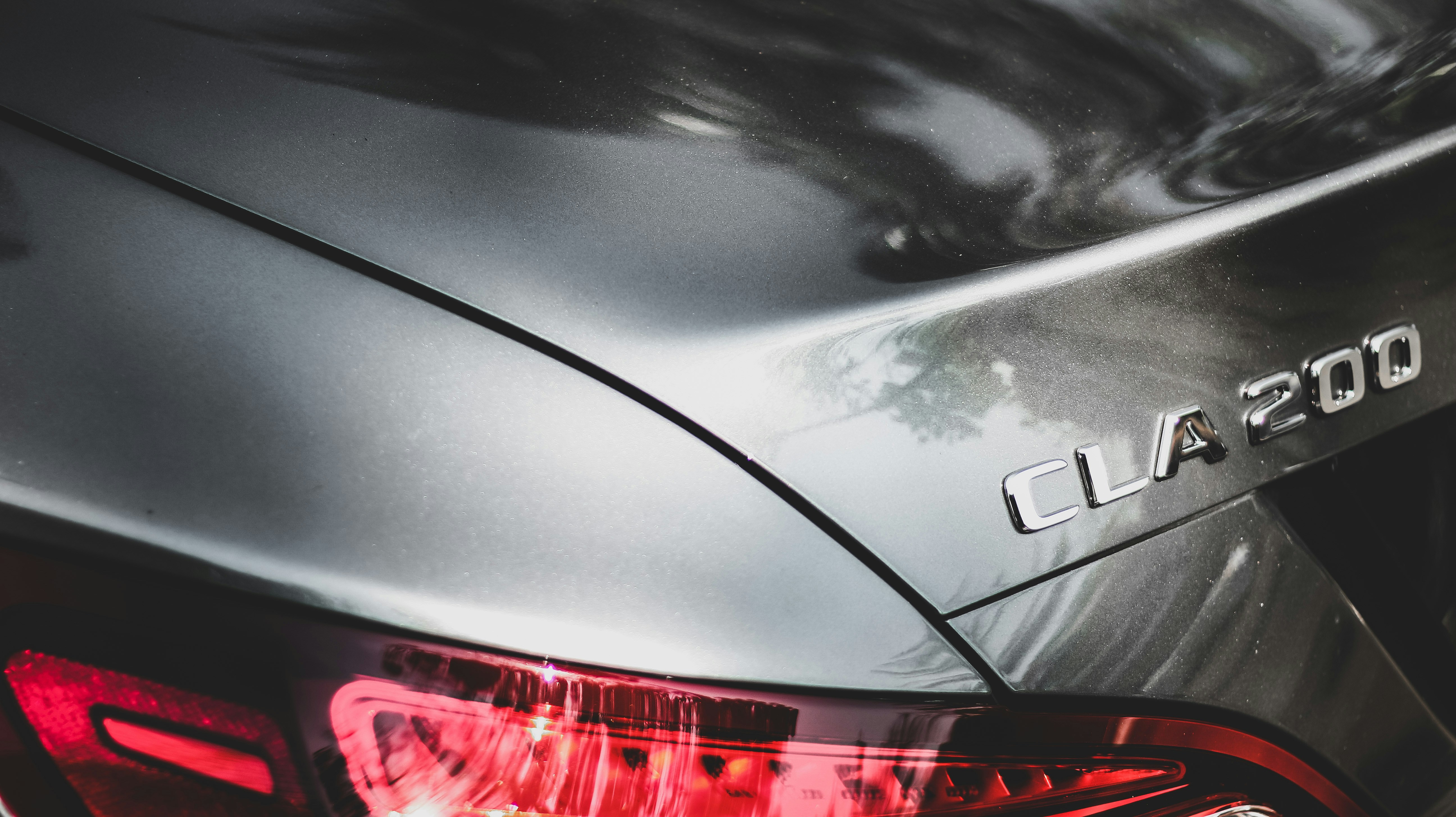 Moonlit Silhouette: The CLA 200 Emblem on a Silver Mercedes