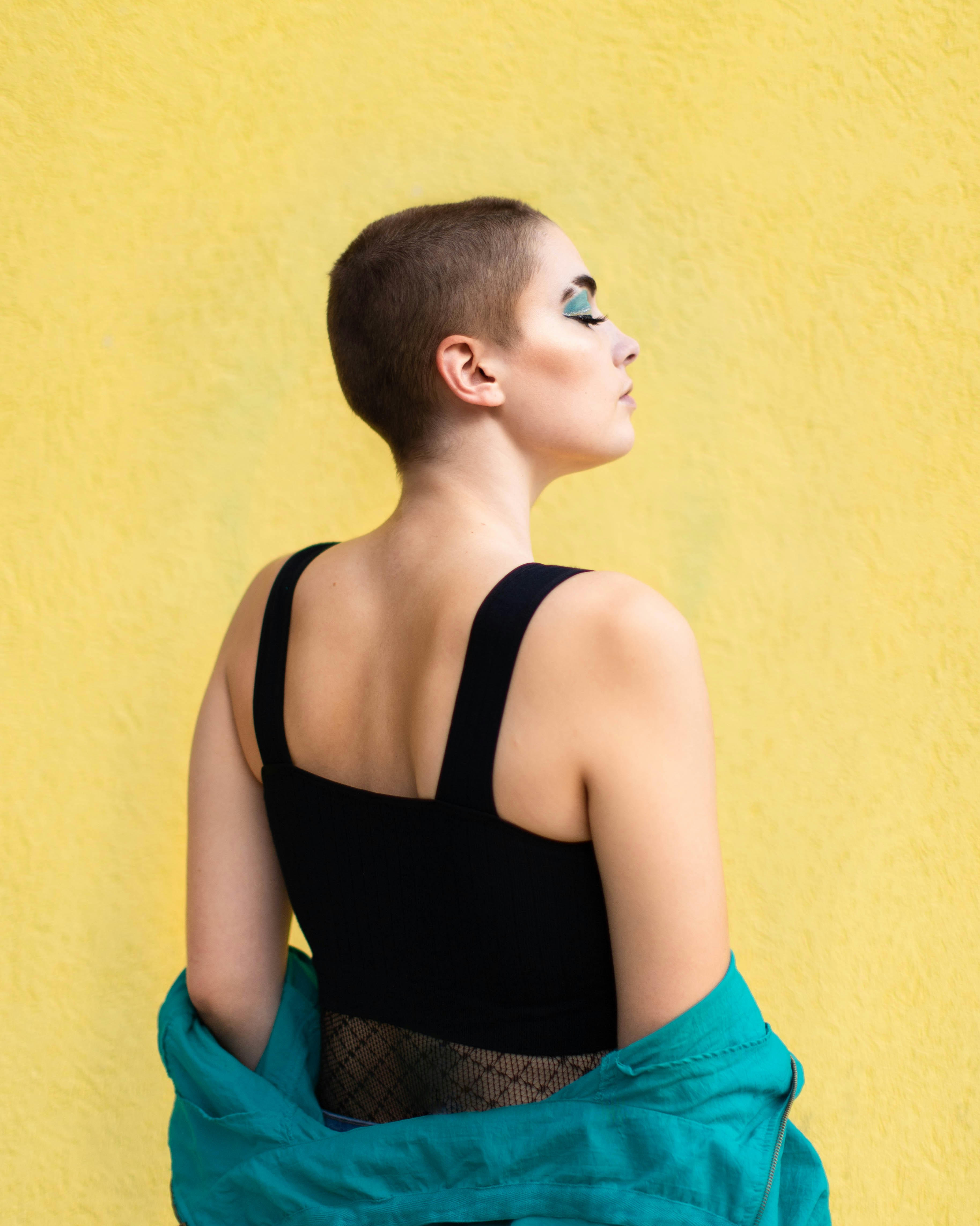 Yellow Wall, Bold Silhouette: A Portrait of Quiet Strength