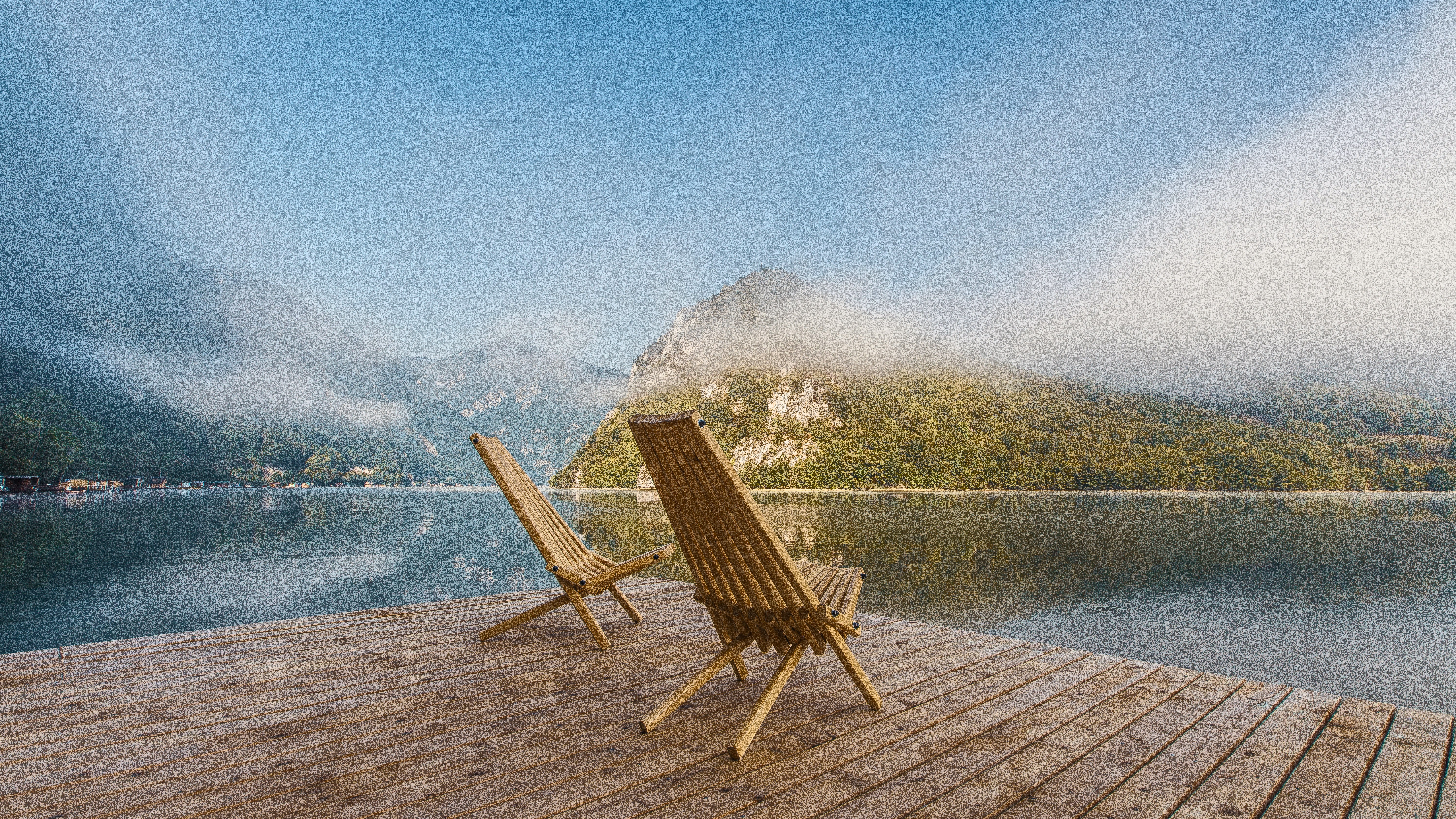 Two Adirondack Chairs Stand Watch Over a Misty Alpine Lake