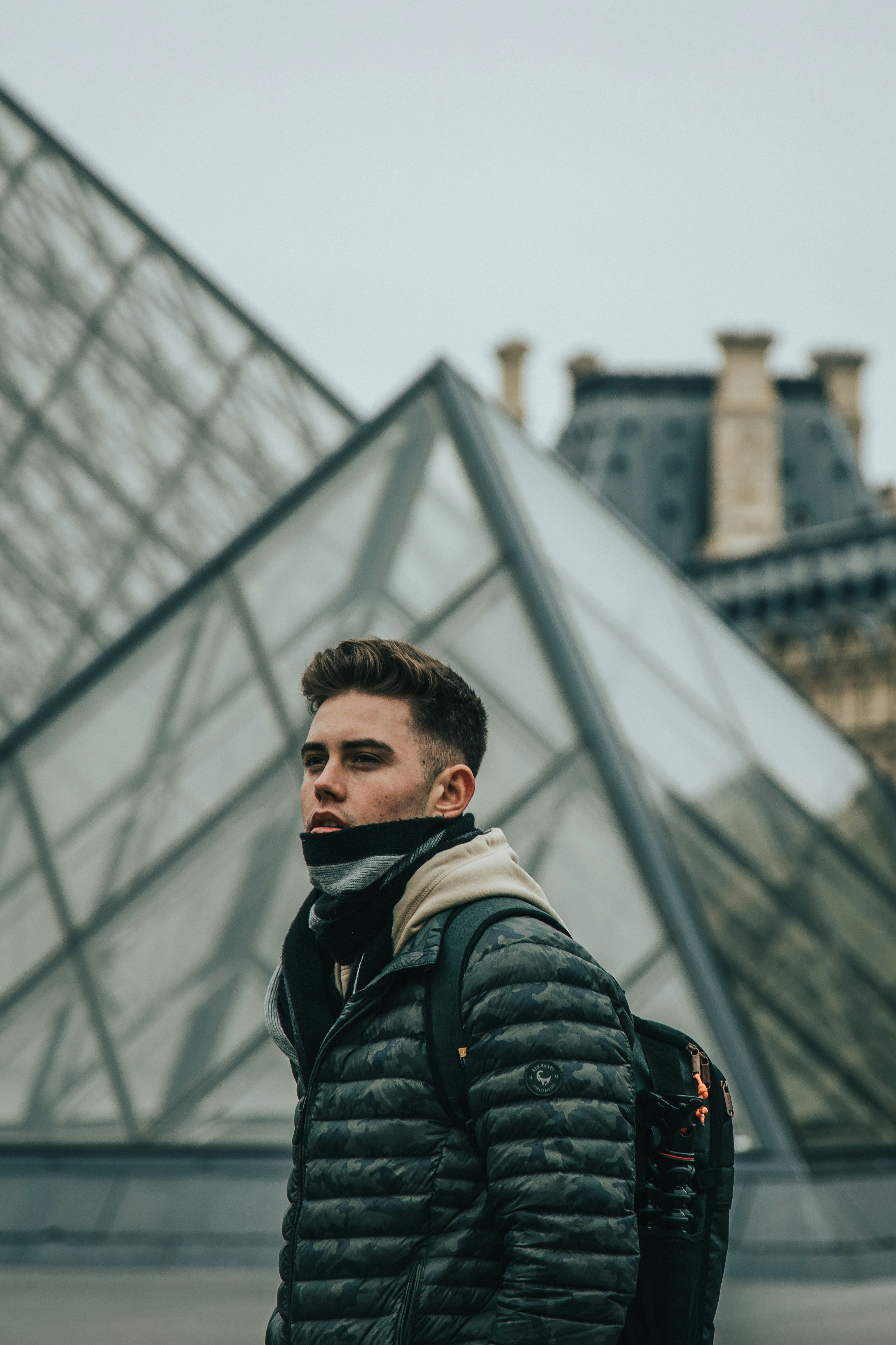 Portrait at the Louvre Pyramid: Quiet Resolve Amid Glass and Stone