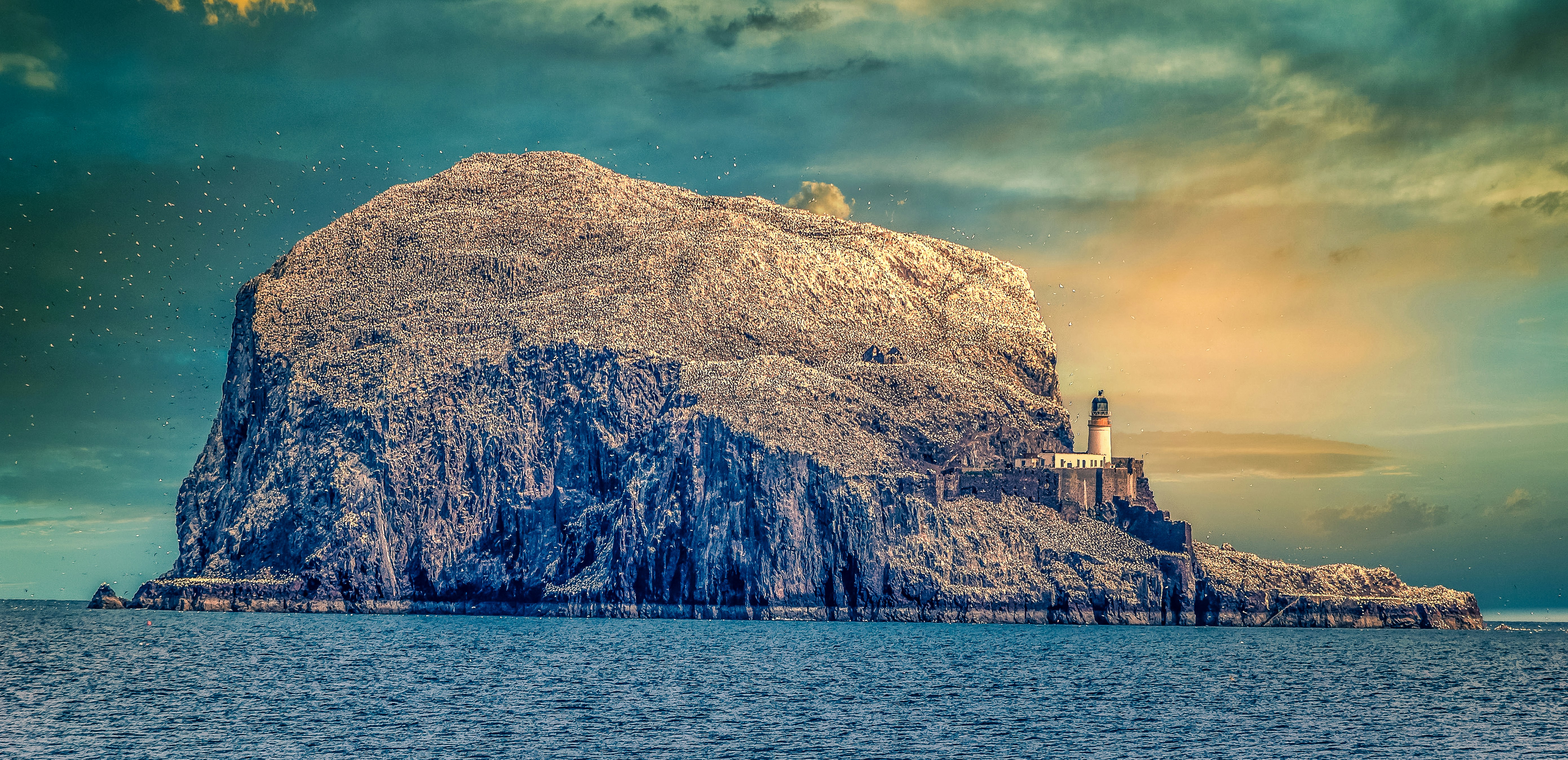 Beacon on the Blue Isle: A Lone Lighthouse Crowned by Sea and Sky