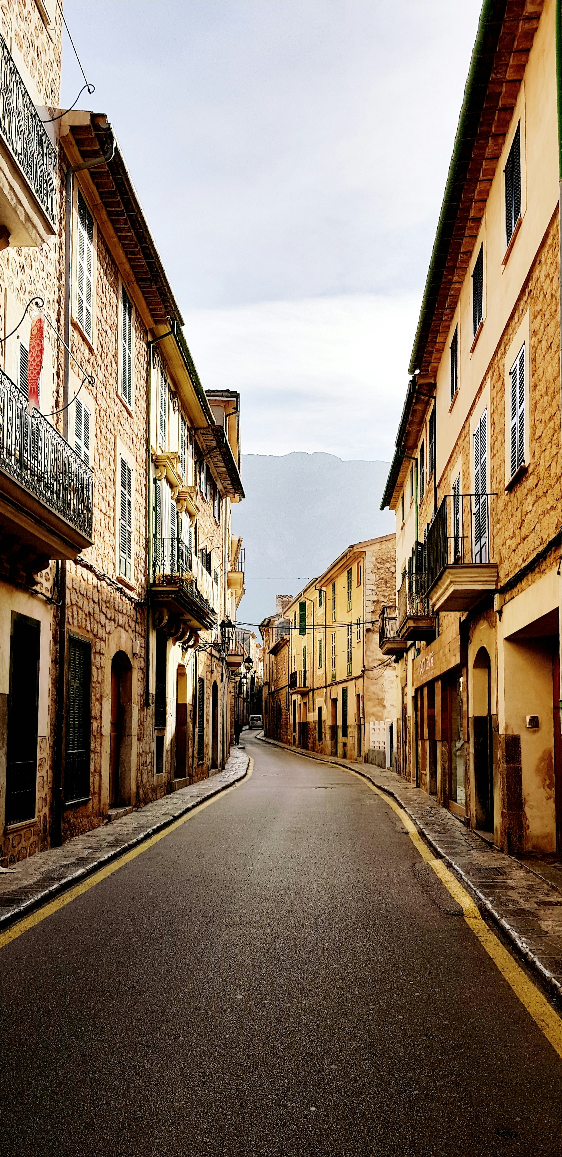 Empty road between concrete buildings during daytime photo – Free ...