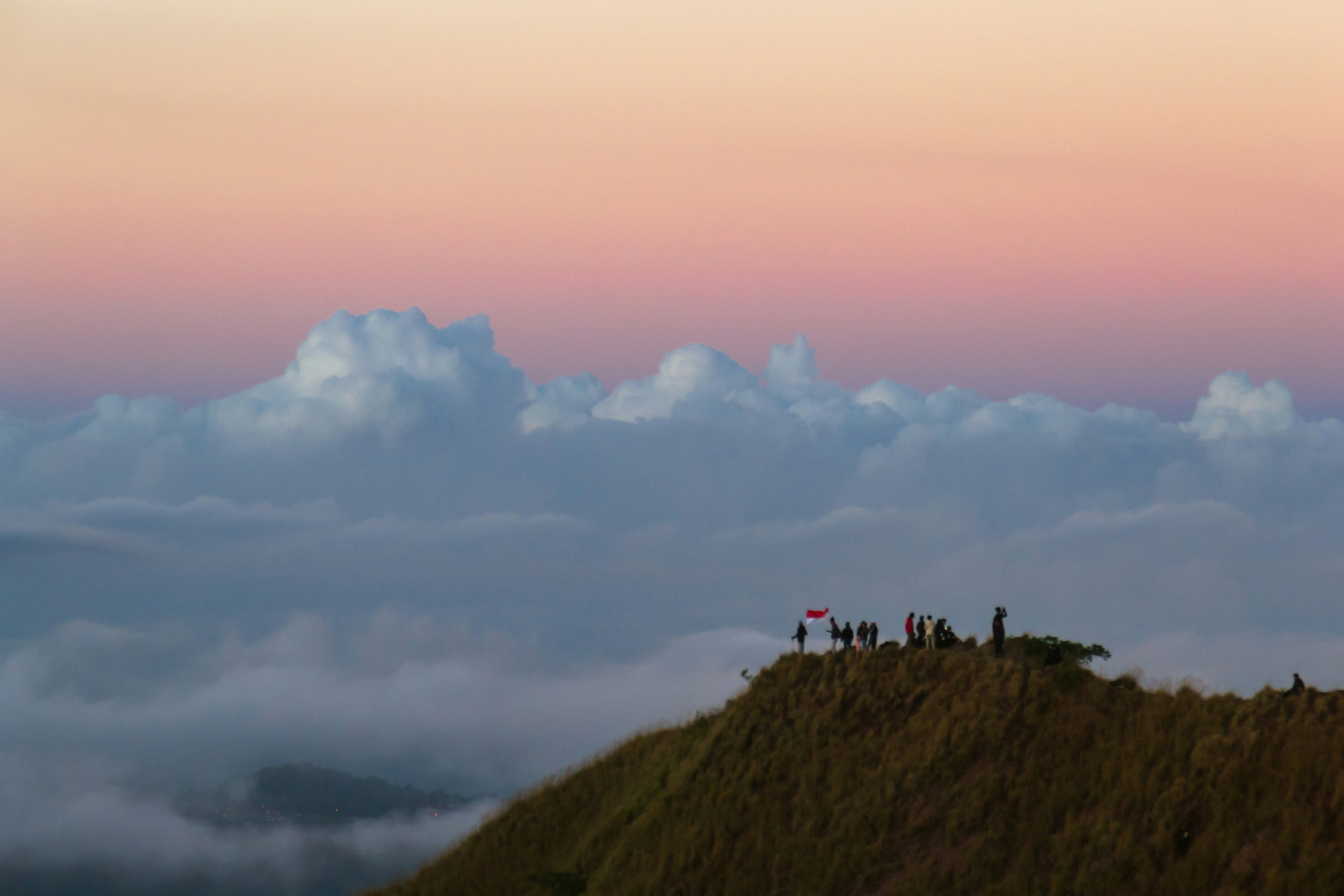 Sunset Ridge Convergence: Hikers on the Cloud-Kissed Summit