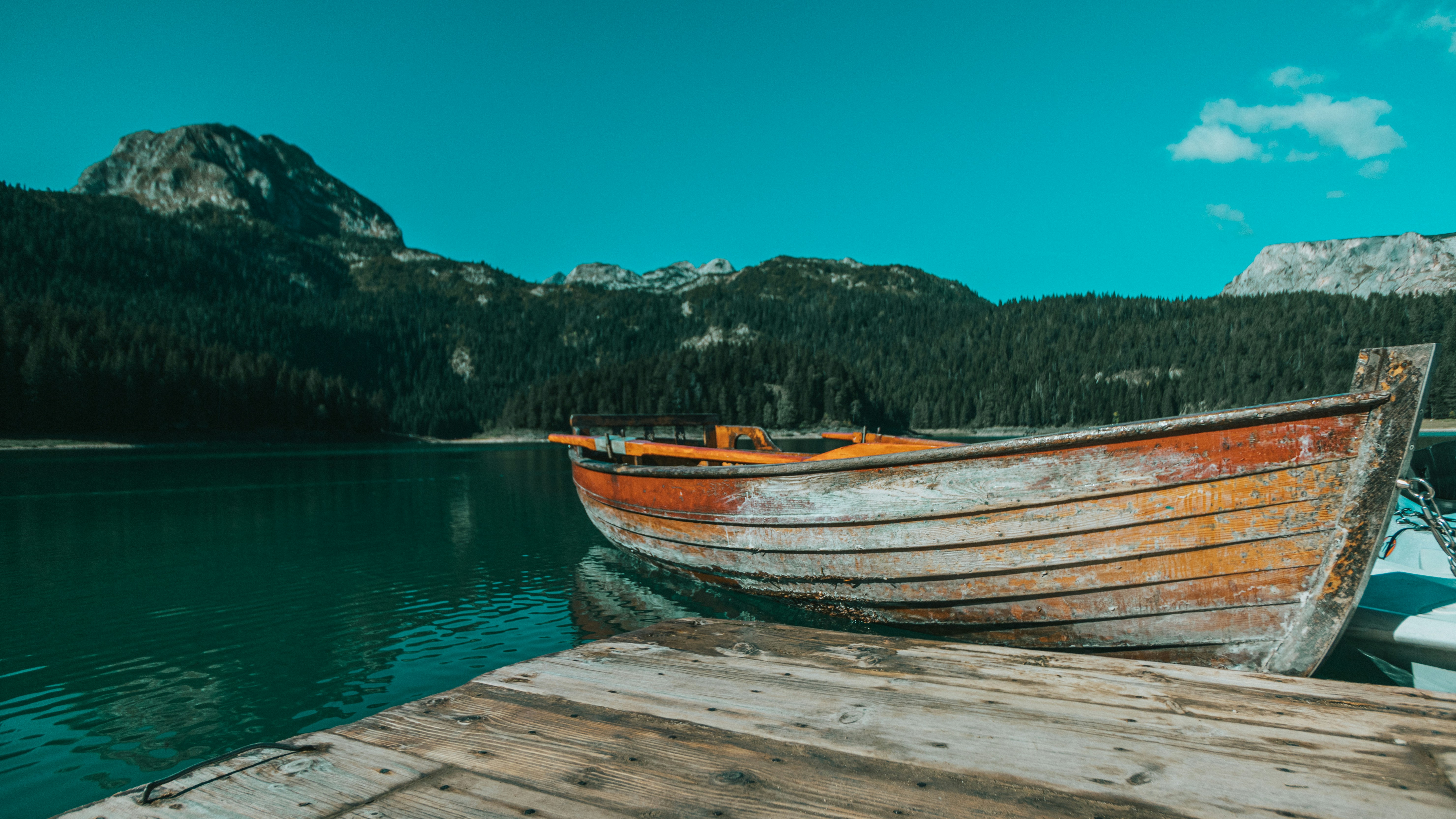 Weathered Vessel Quietly Anchored on an Emerald Alpine Lake