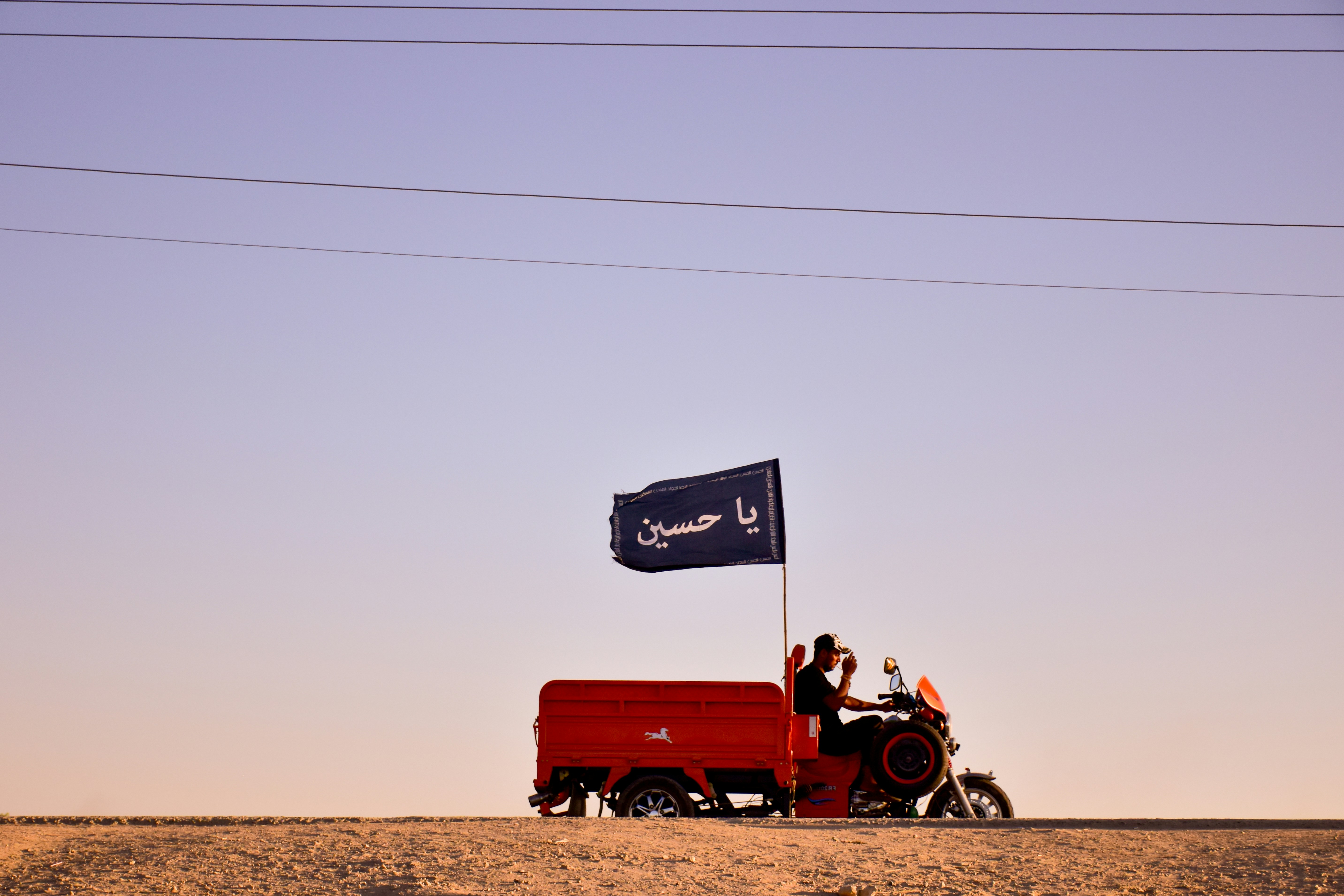Desert Caravan: A Red Tractor and Riders Meet the Distant Horizon