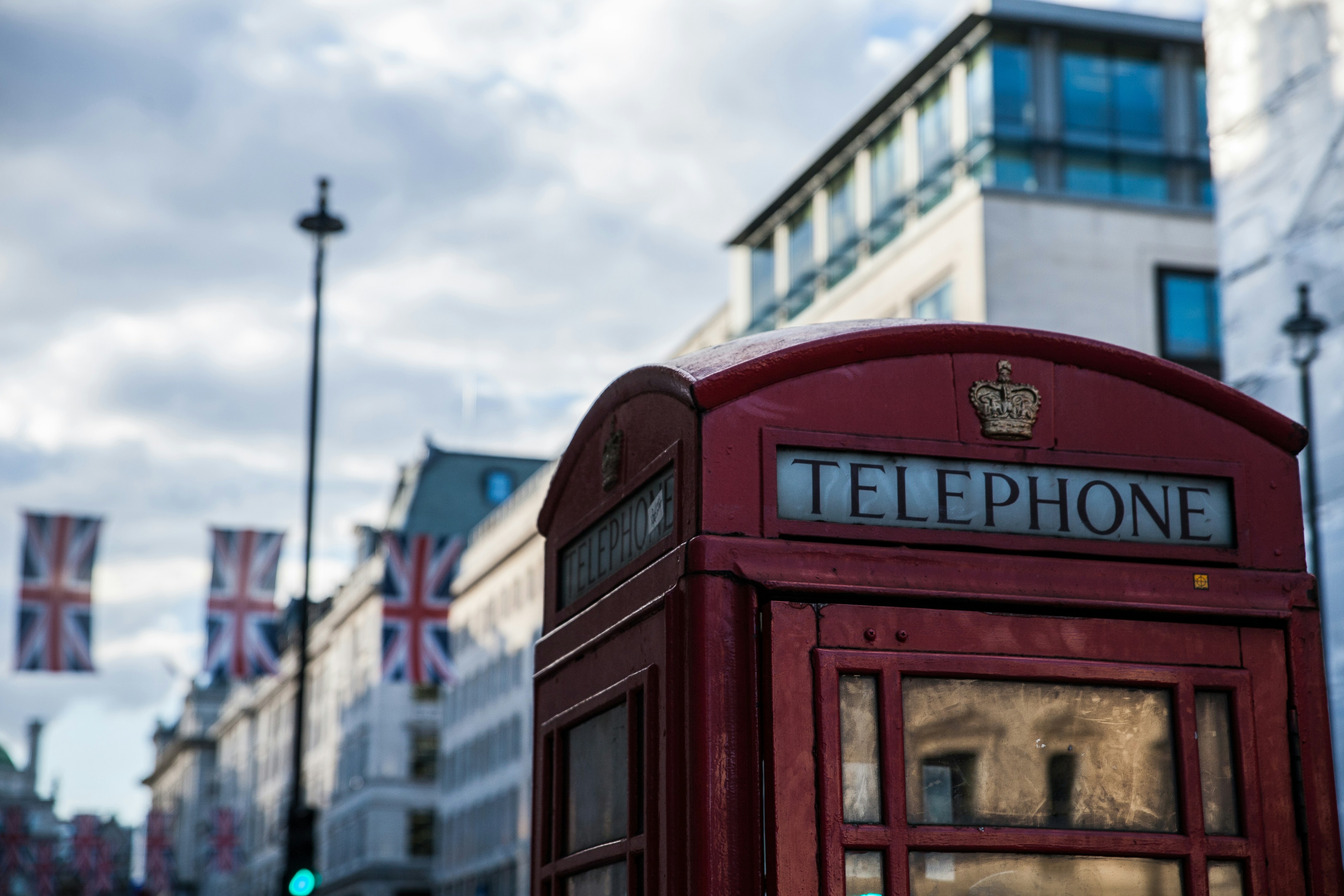 Red telephone booth near brown building during daytime photo – Free ...