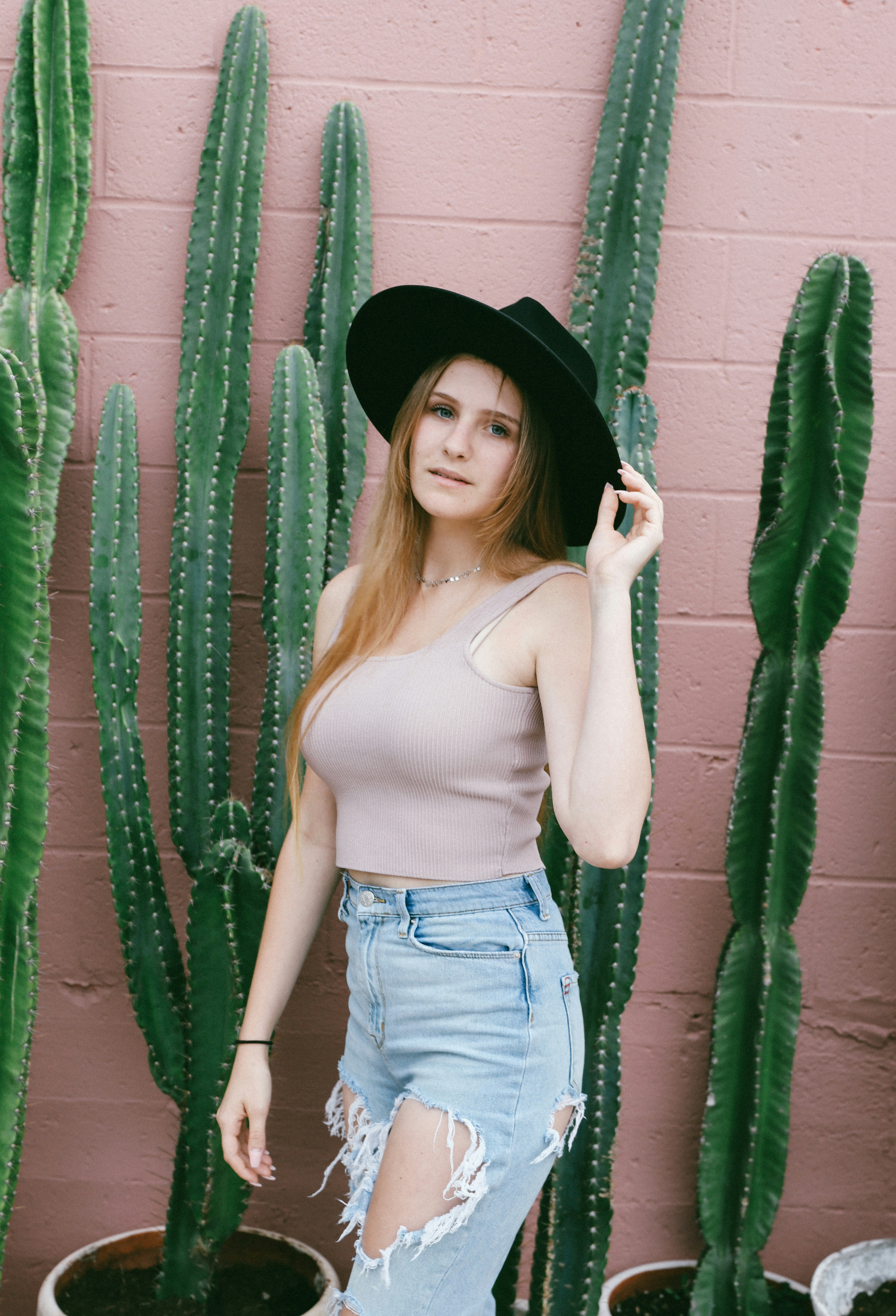 Pink-Wall Portrait Amid Cactus Sentinels