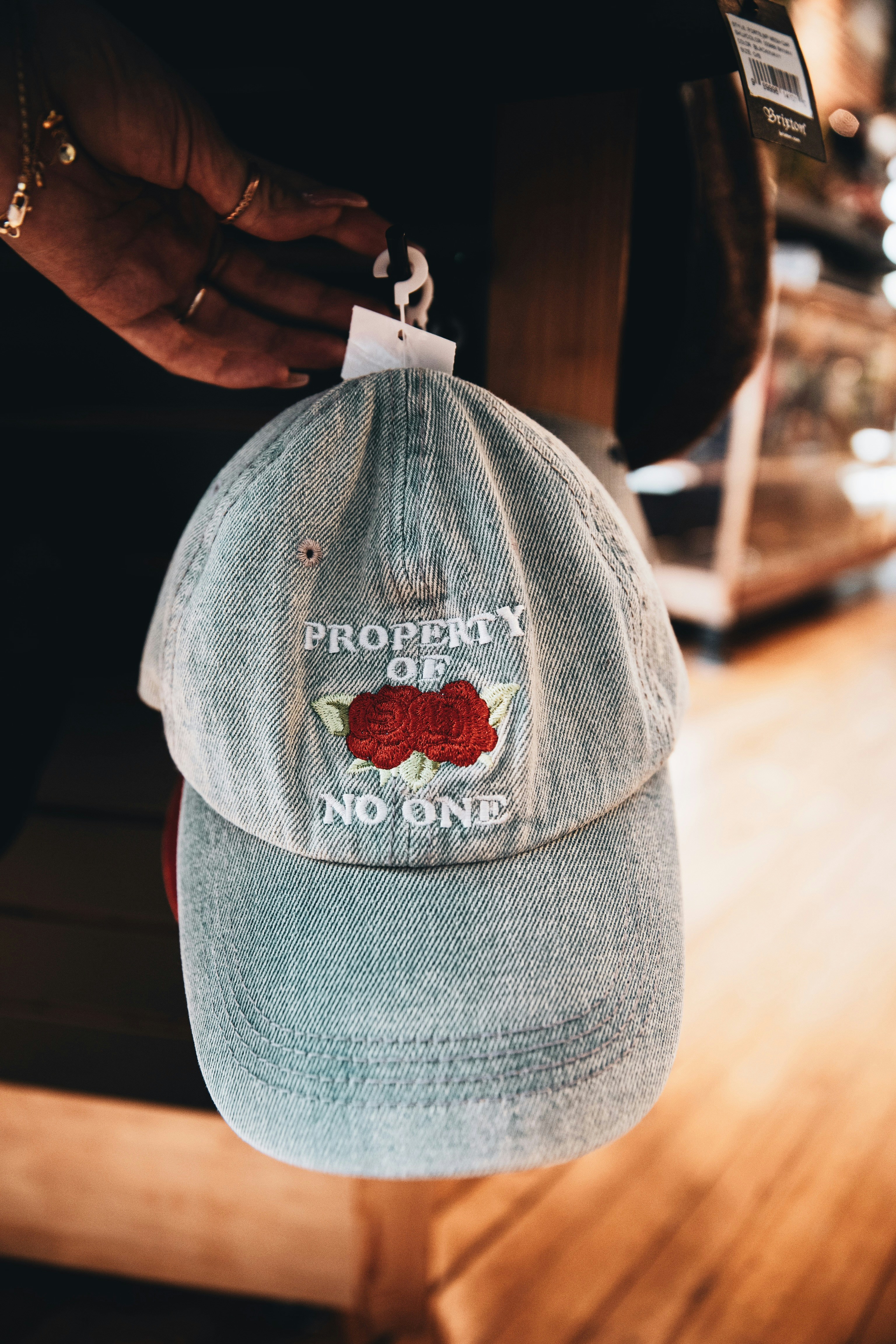 Property of No One: Denim Cap with Rose Crest in a Storefront Moment