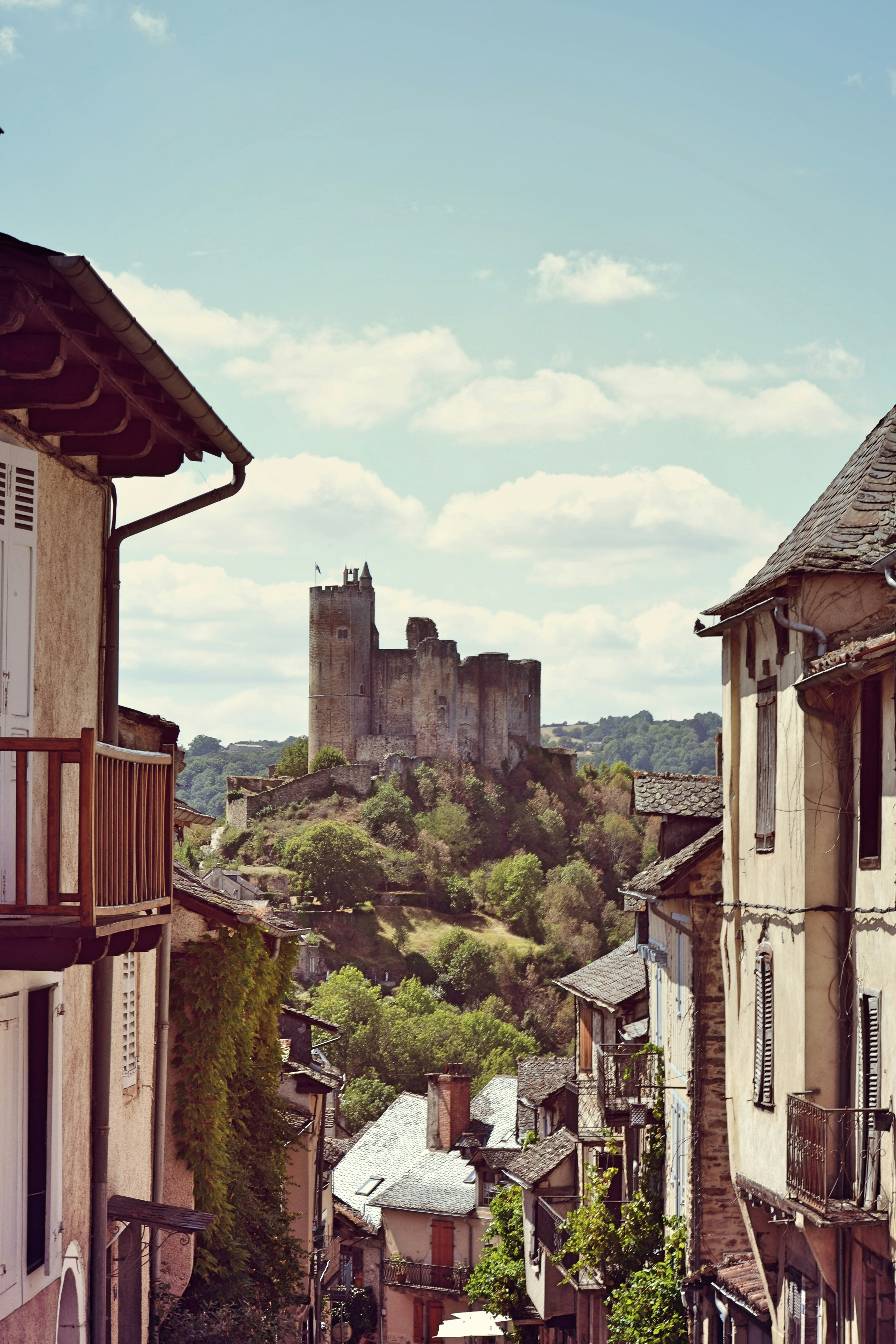Castle on the Hill: Sunlit village streets frame a distant fortress.